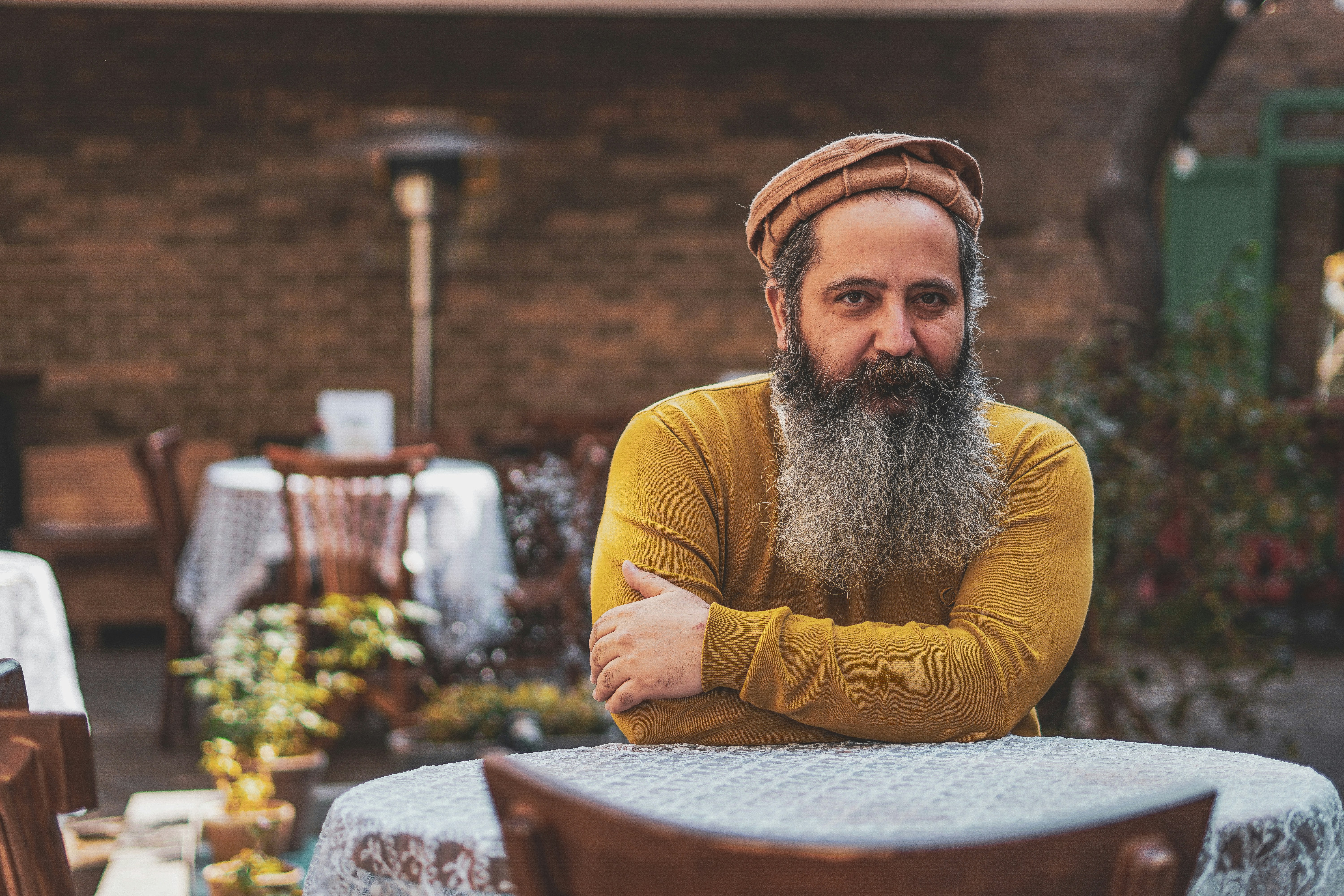 Mustard Knit at an Outdoor Café: A Quiet Portrait