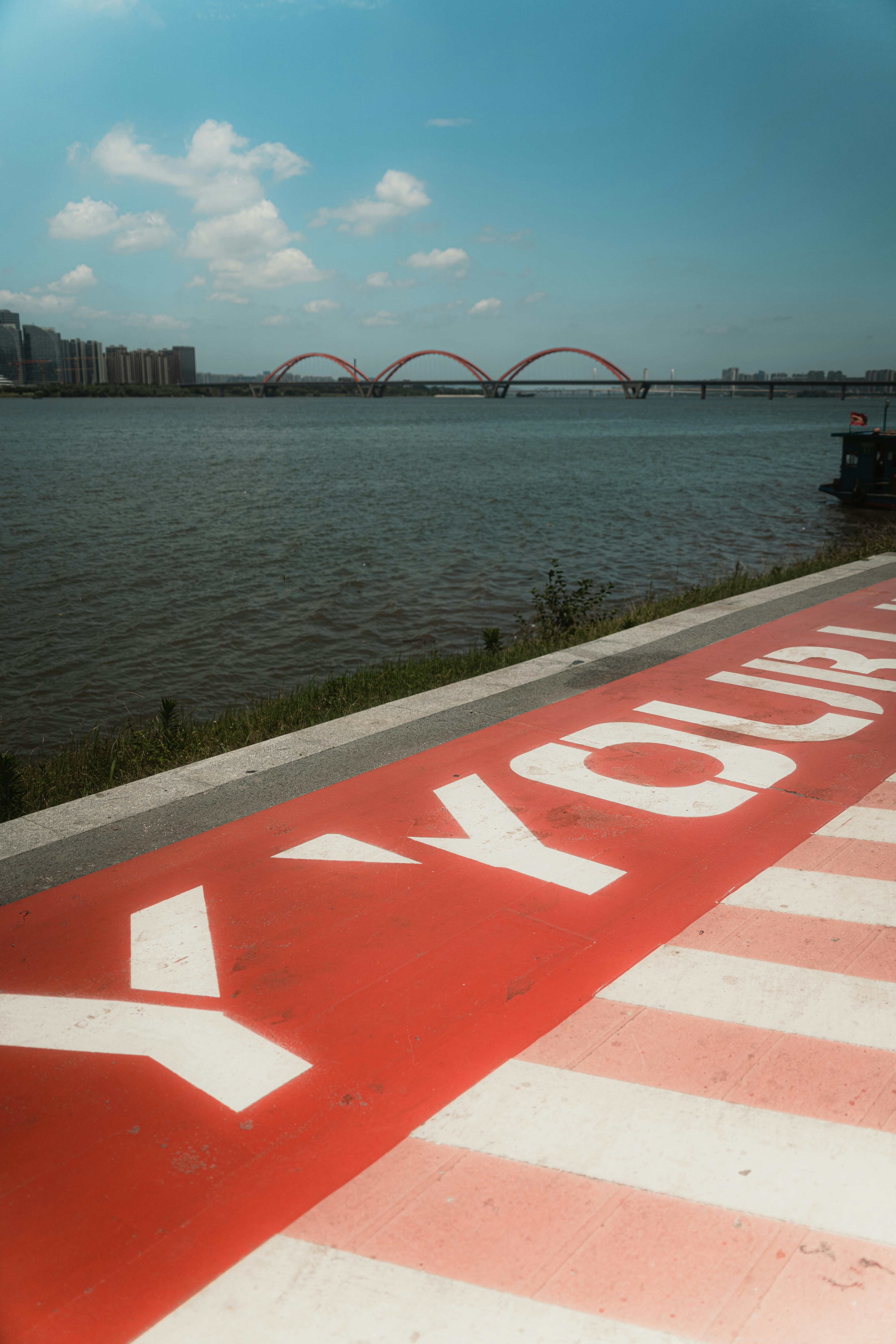 Red Arches Over the River: A Riverside Road Snapshot