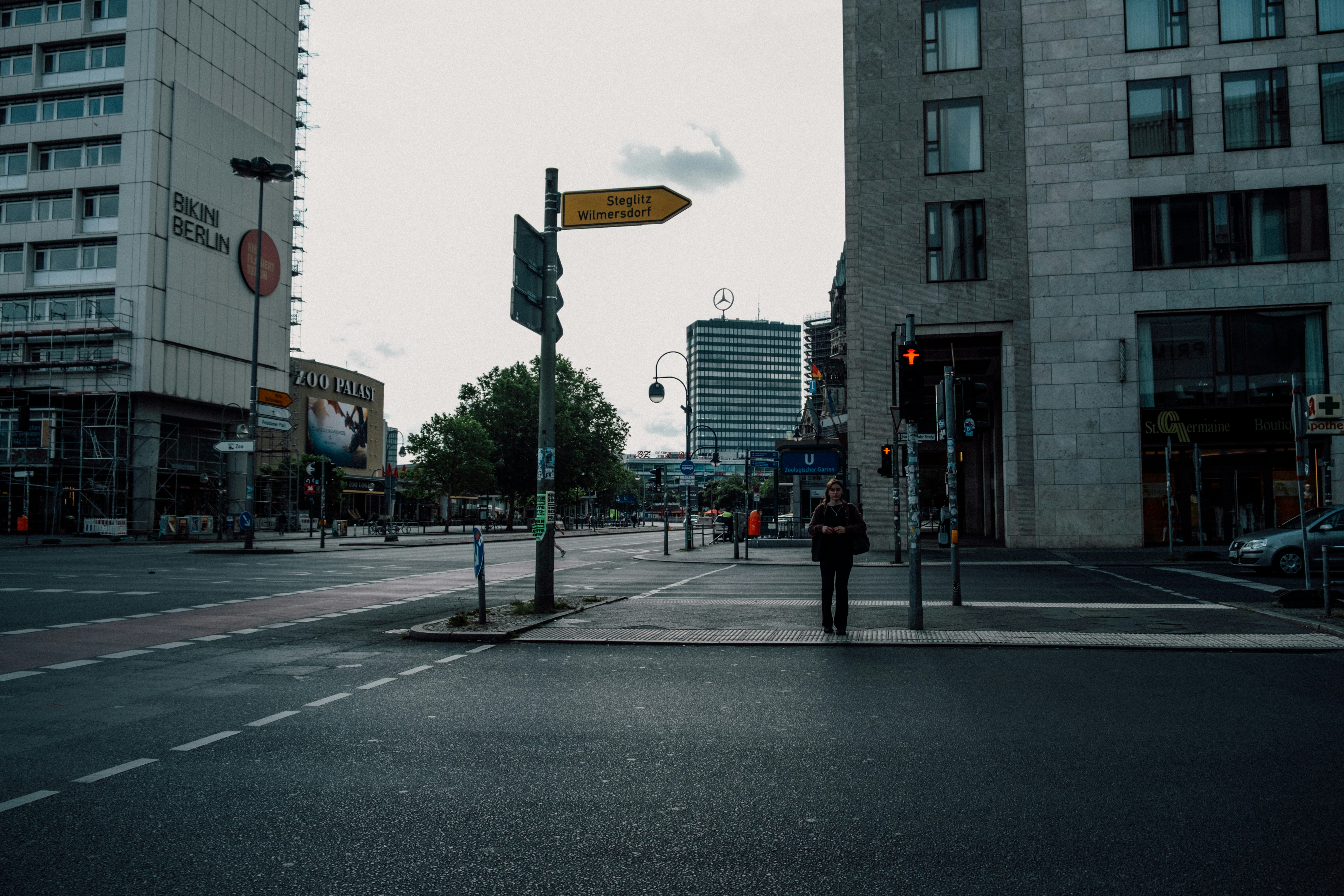 A city street scene with buildings and signs.
