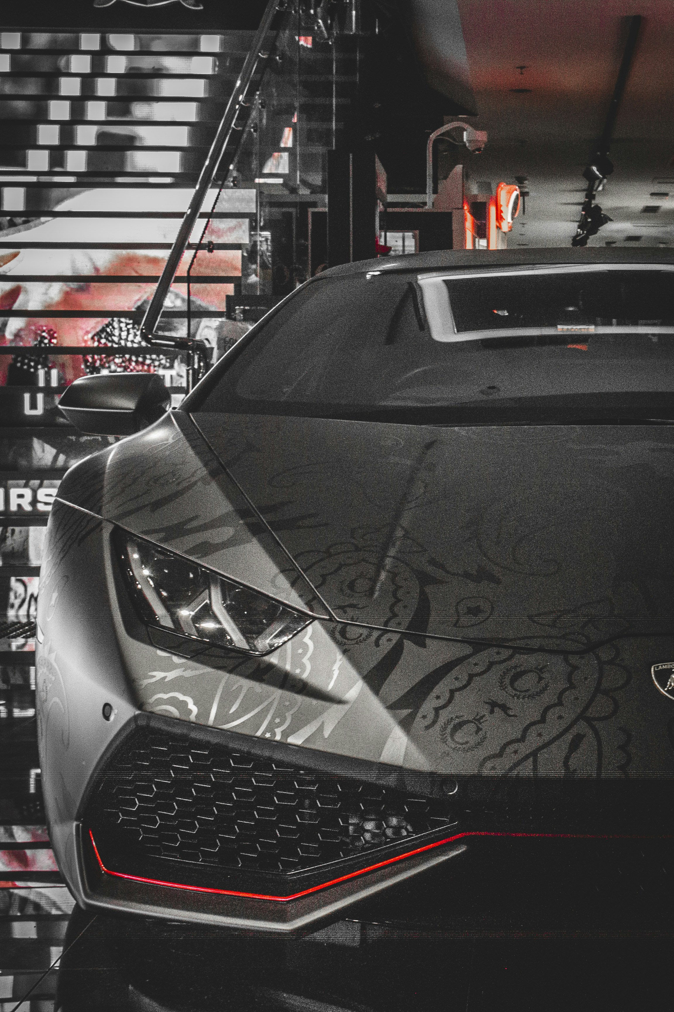 Neon-Trimmed Edge: Front View of a Matte Lamborghini in Urban Night