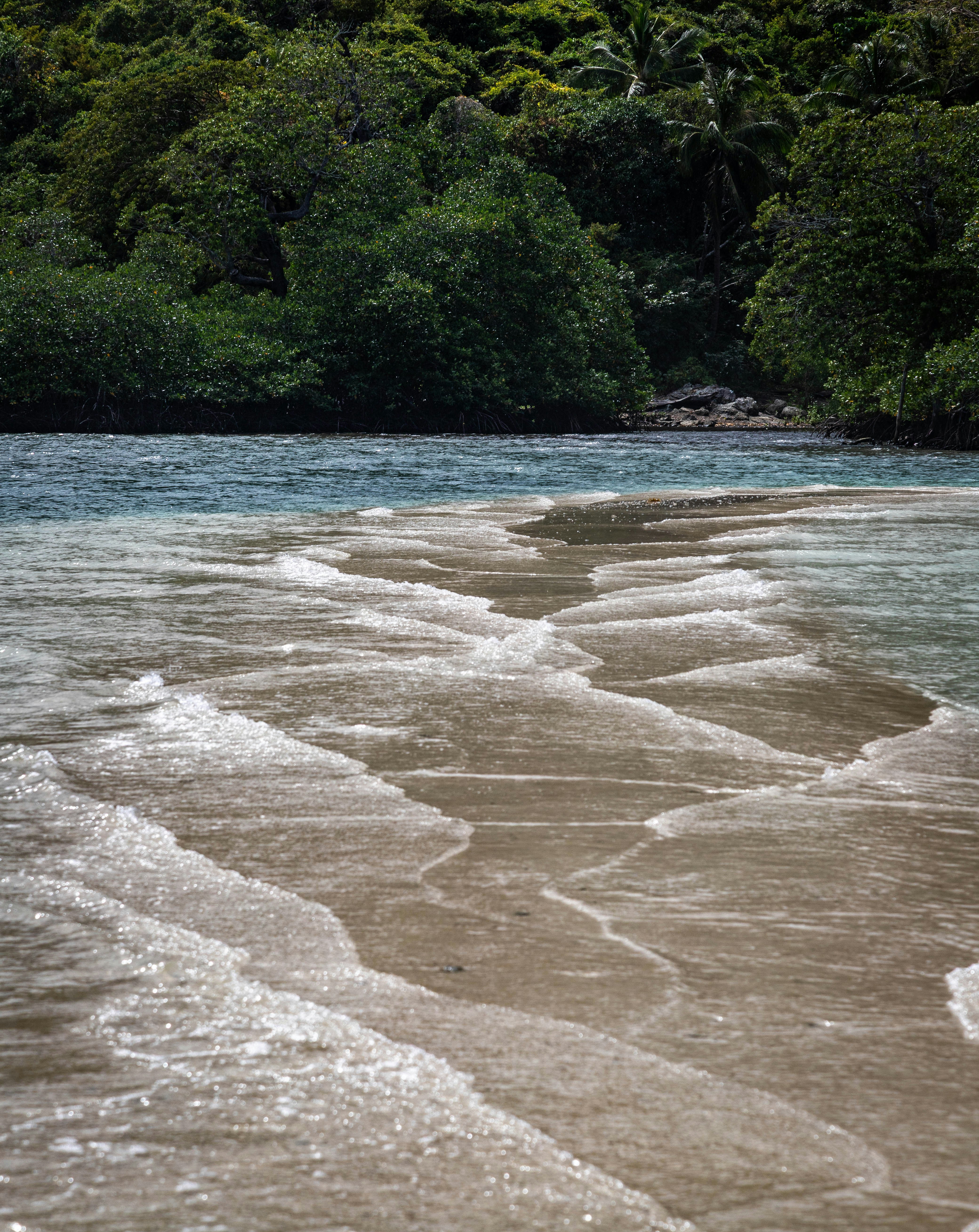 Waves gently wash over a shallow, rocky passage. photo – Free Beach ...