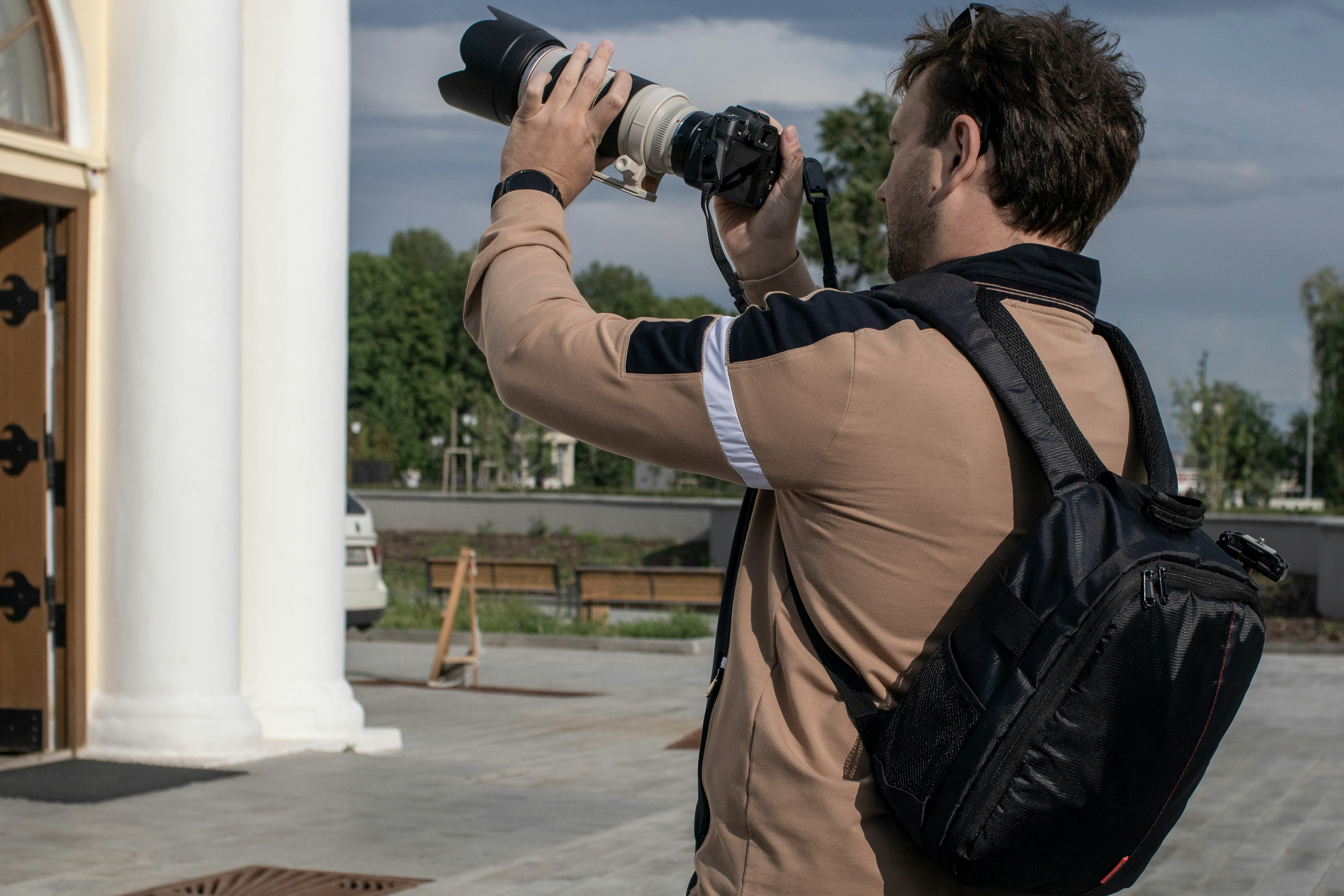 A photographer is capturing a photo outdoors.