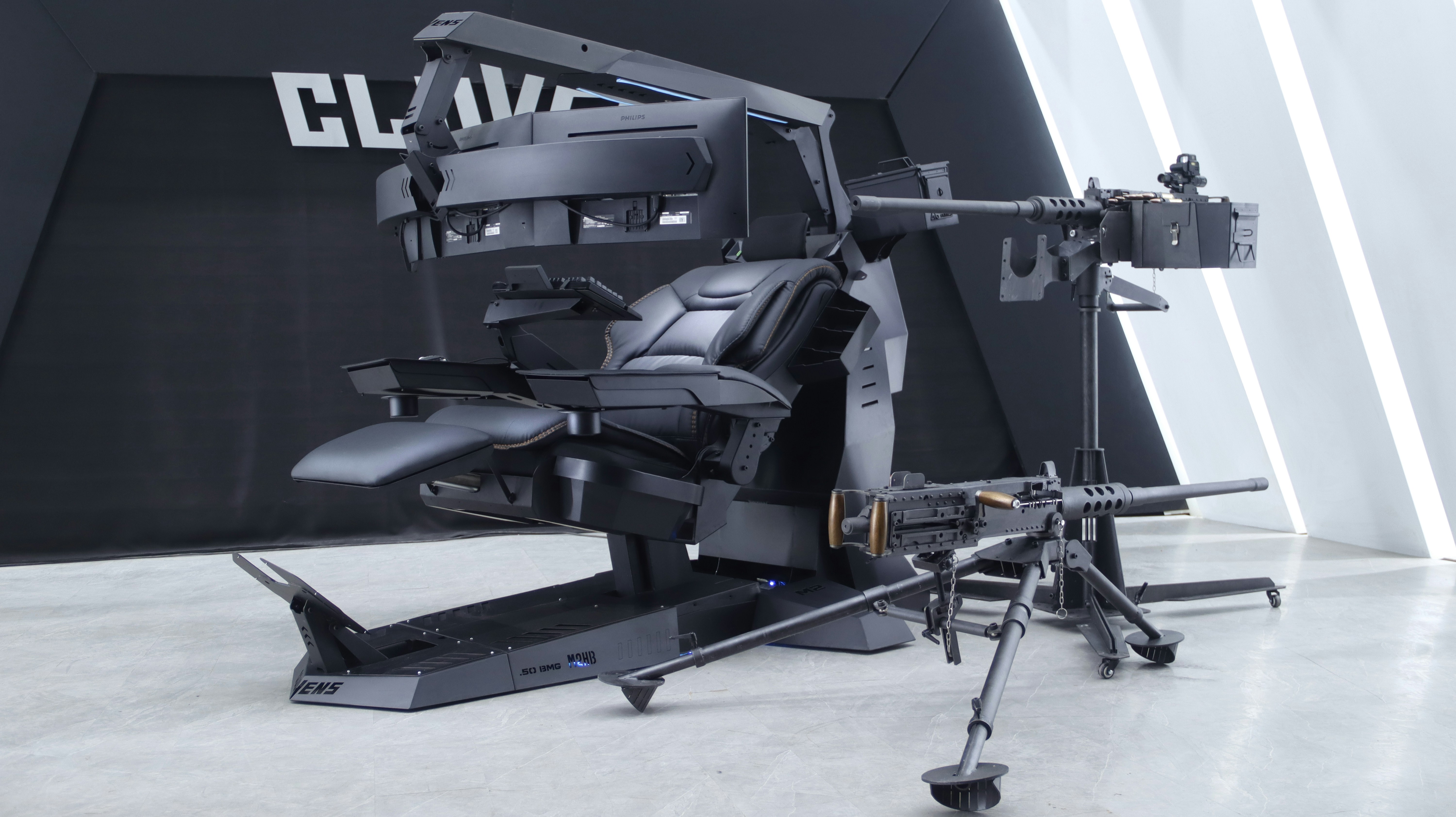 A futuristic gaming chair with multiple screens and a weapon. photo ...