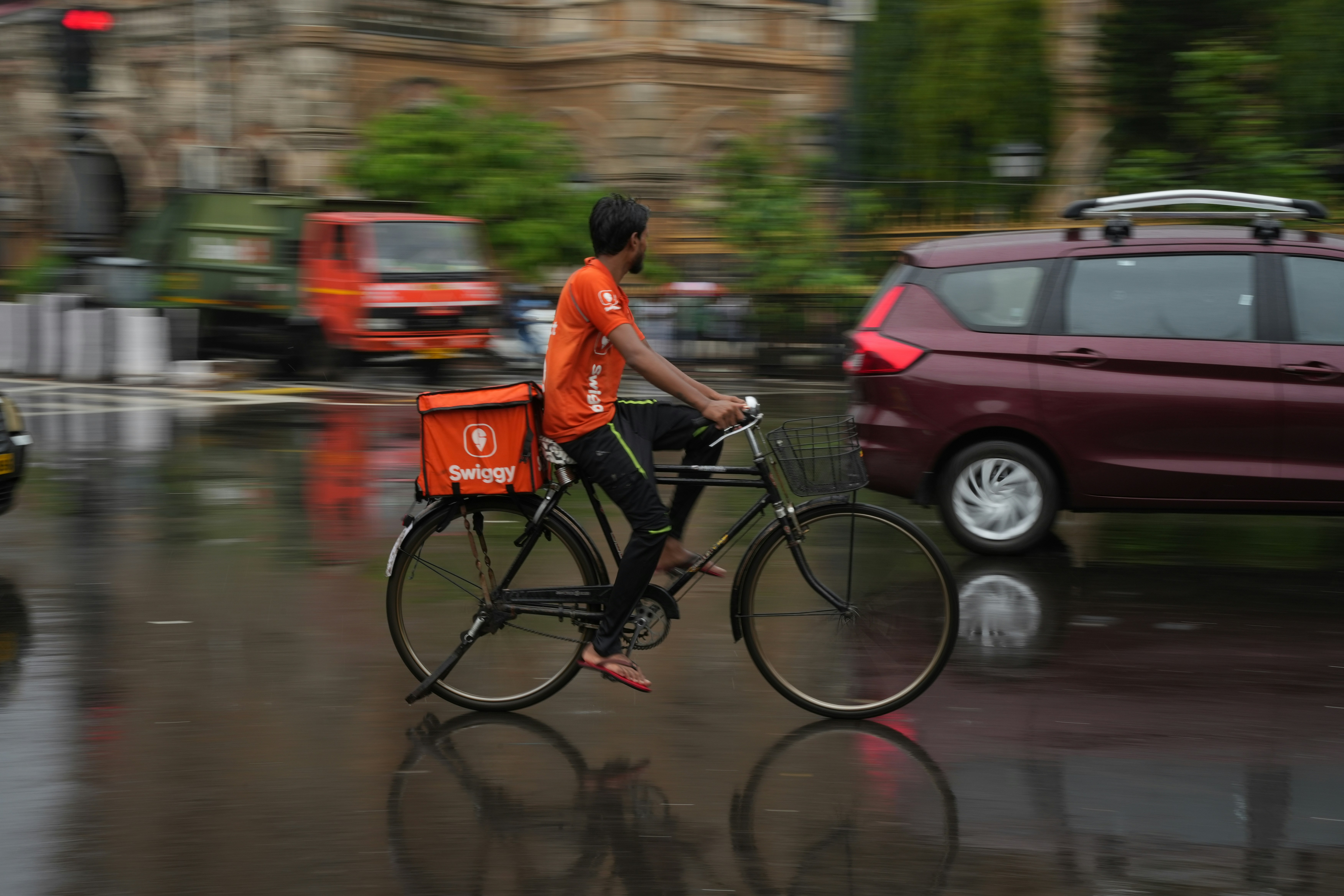 Urban Delivery Cyclist in Motion on A Rain-Slick Road