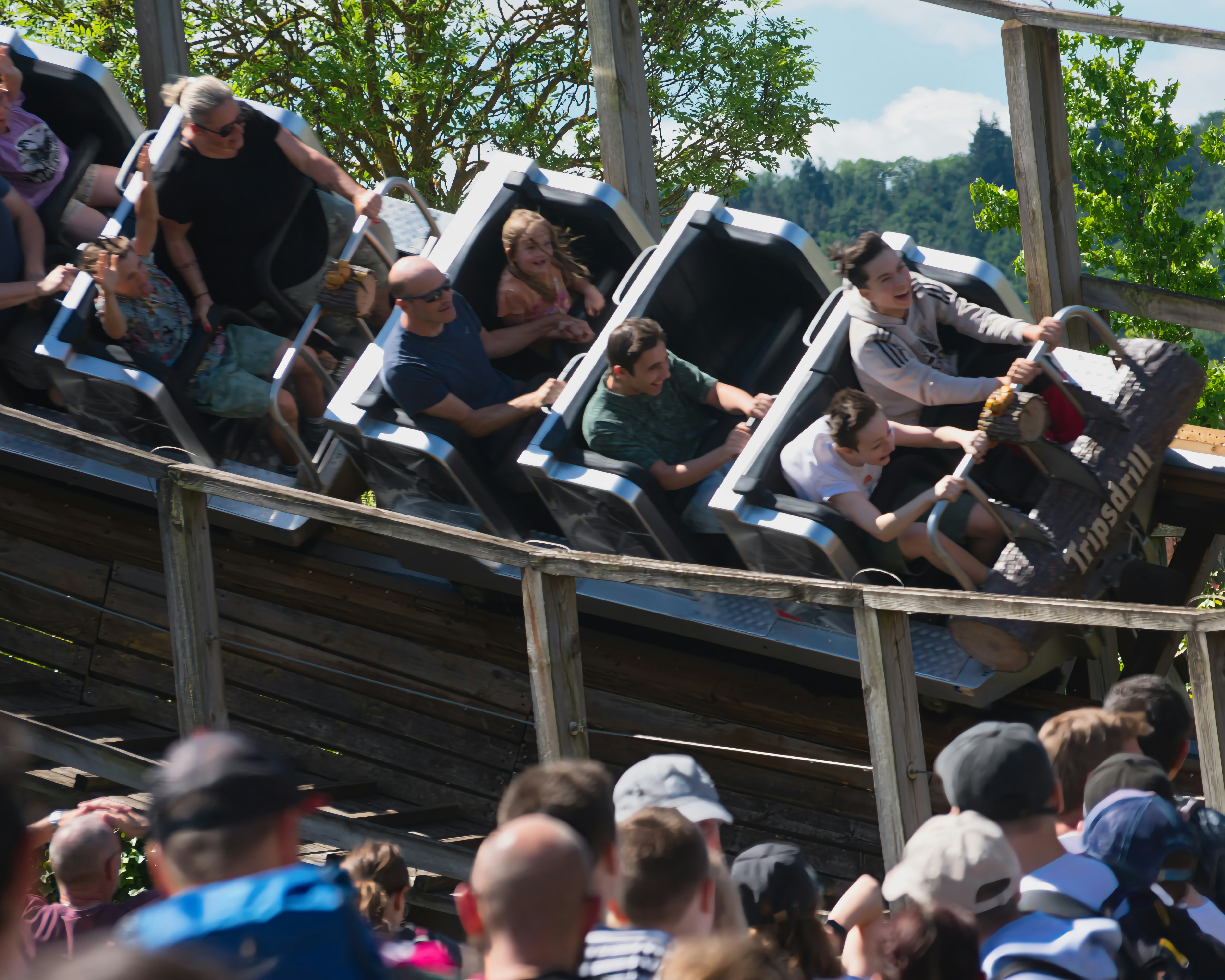People enjoy a roller coaster ride at an amusement park. photo – Free ...