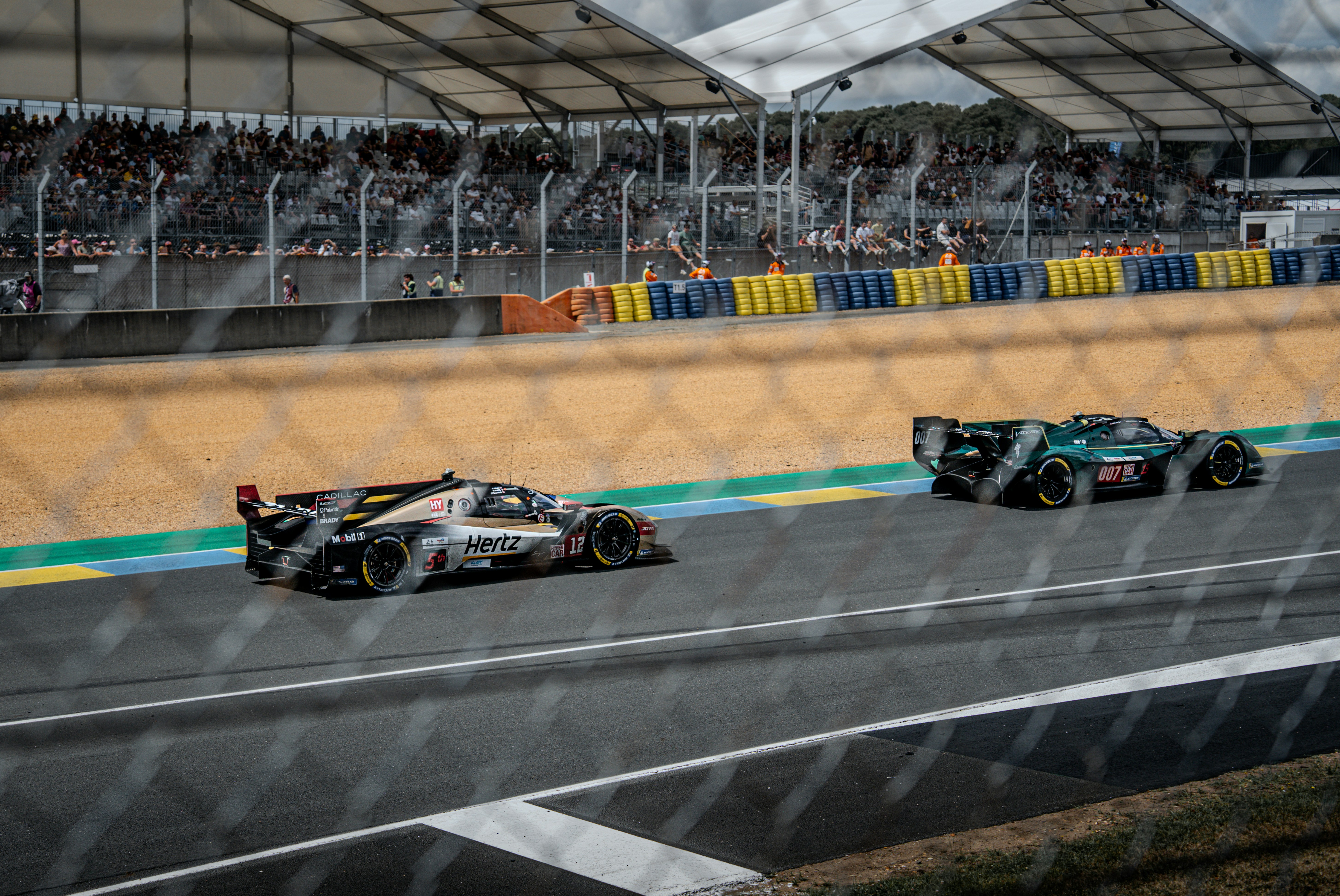 Race cars speeding around a track with spectators. photo – Free Car ...