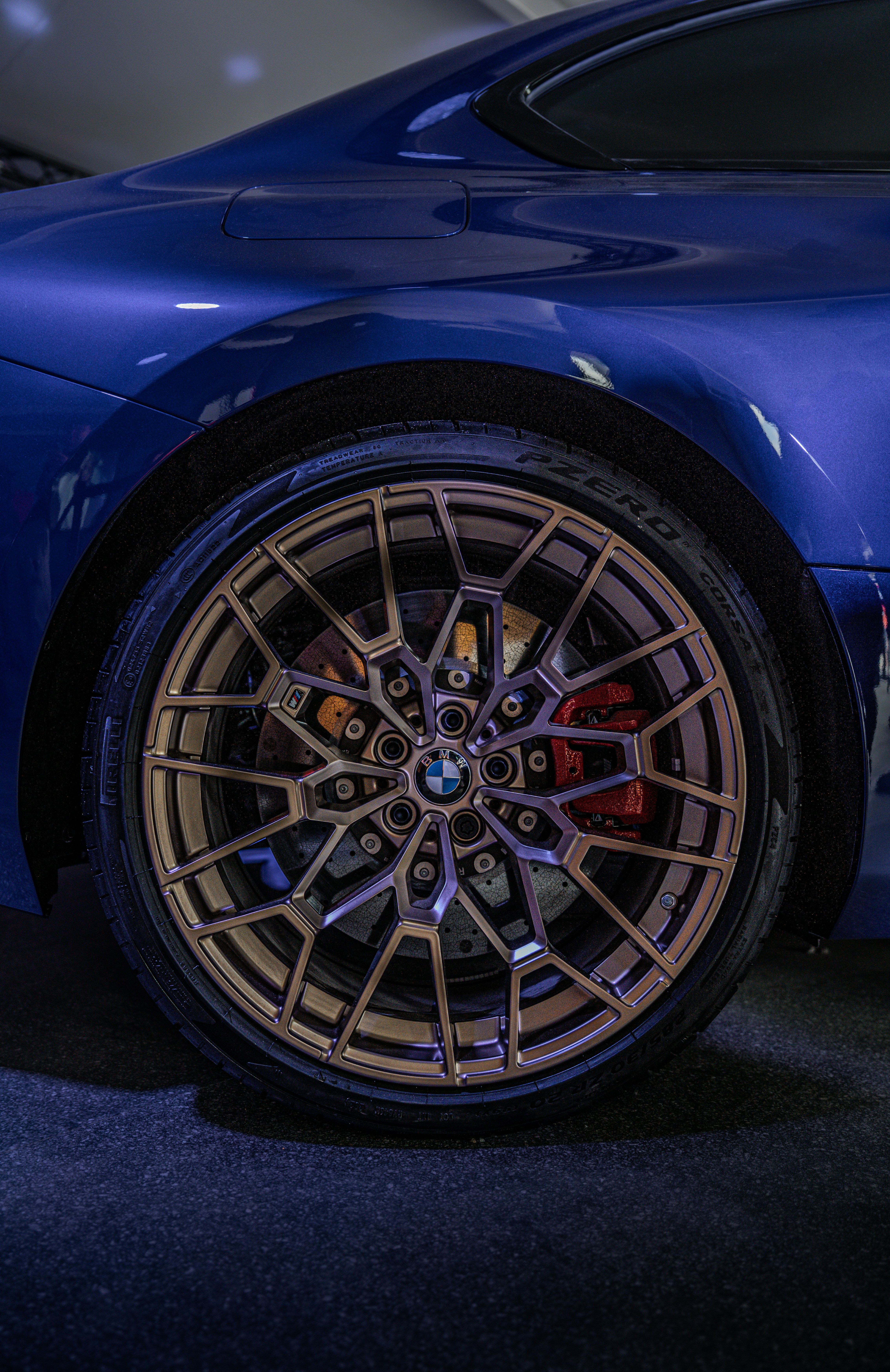 A blue BMW car with golden wheels is shown.Thibault Lam Tran