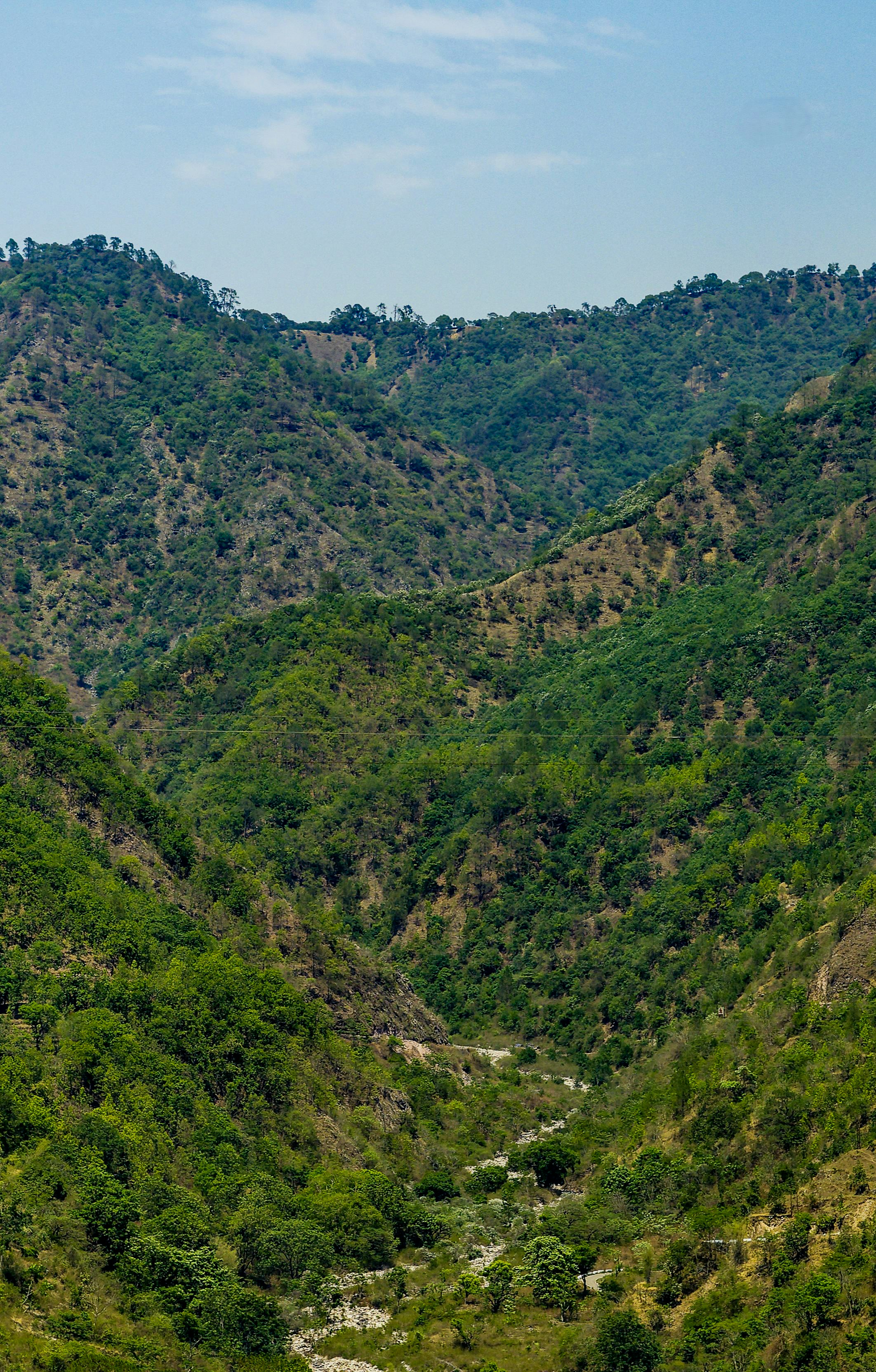 Green mountains and valleys fill the landscape.