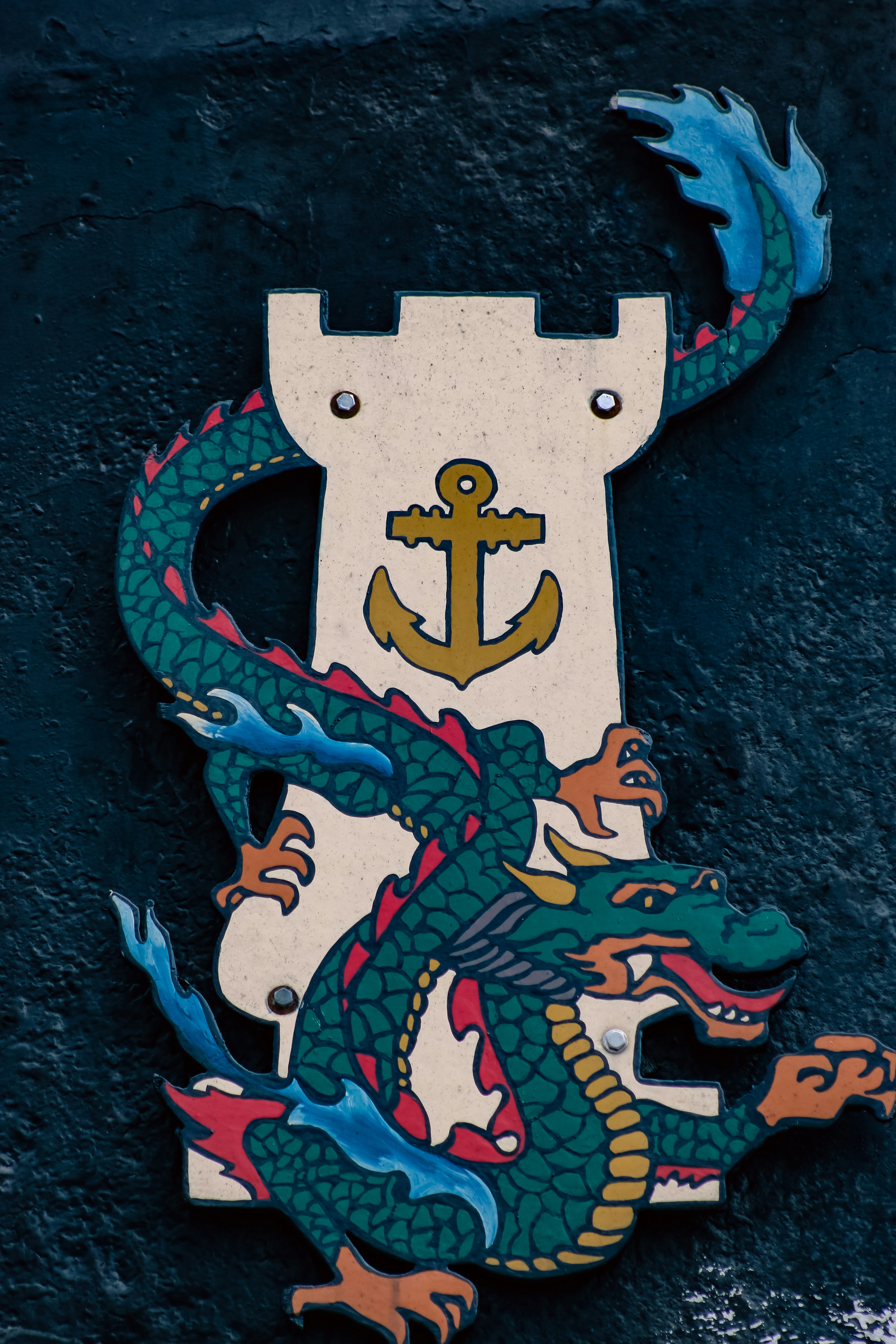 Vibrant illustration of a dragon entwined around a castle tower with an anchor, set against a textured dark background.