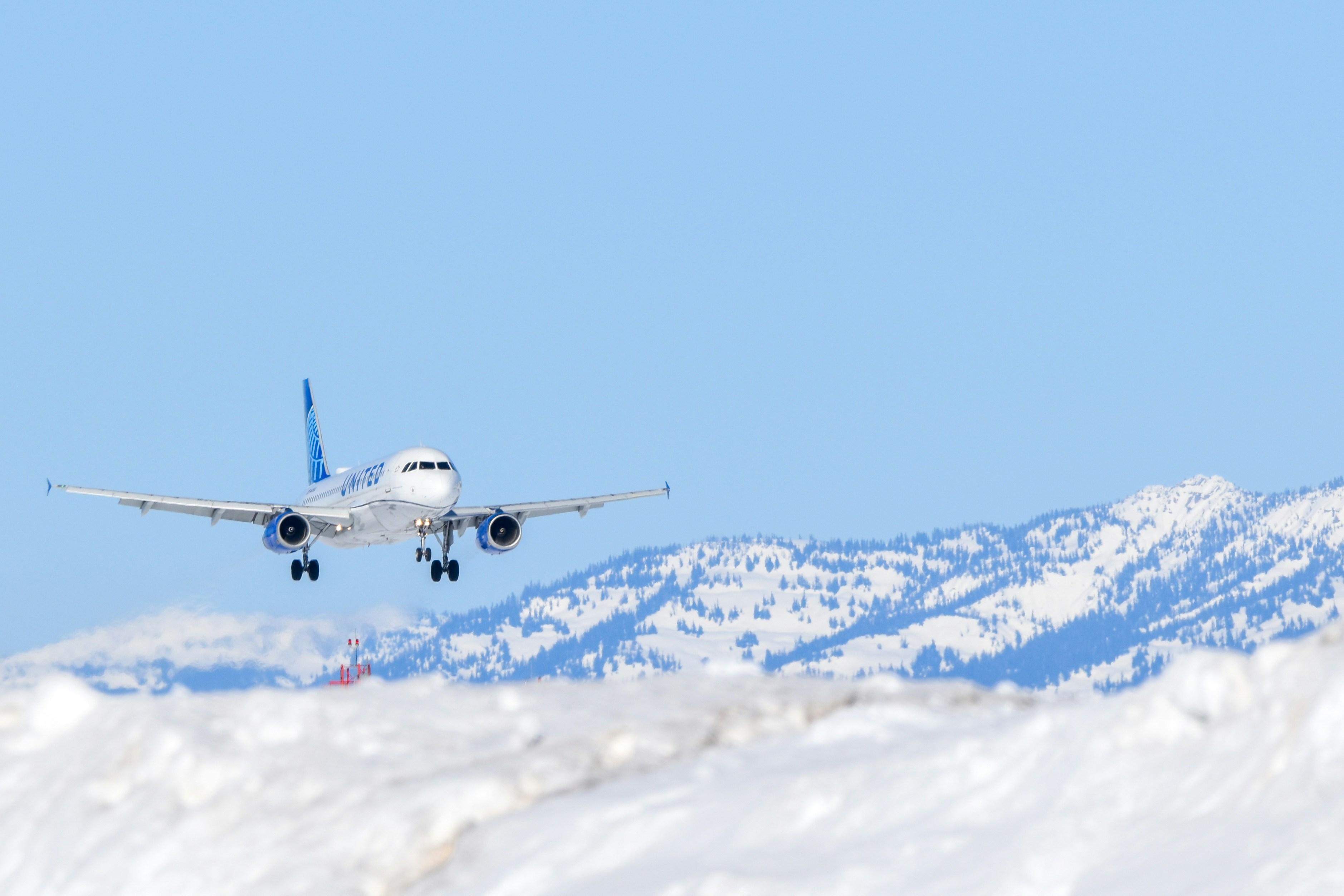 An airplane is approaching a snow-covered runway. photo – Free Airplane ...