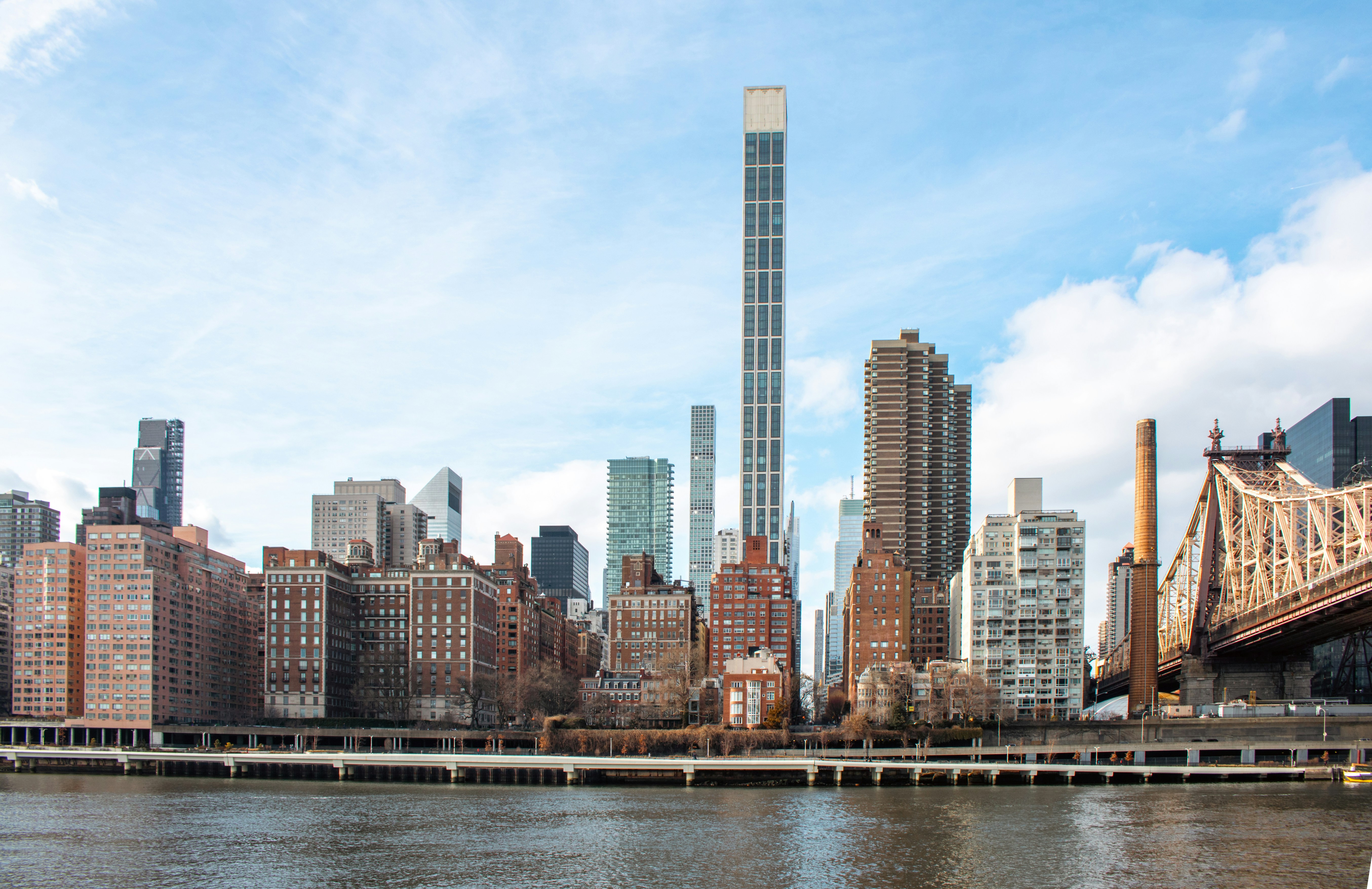 Skyscrapers dominate the cityscape against a cloudy sky. photo – Free ...