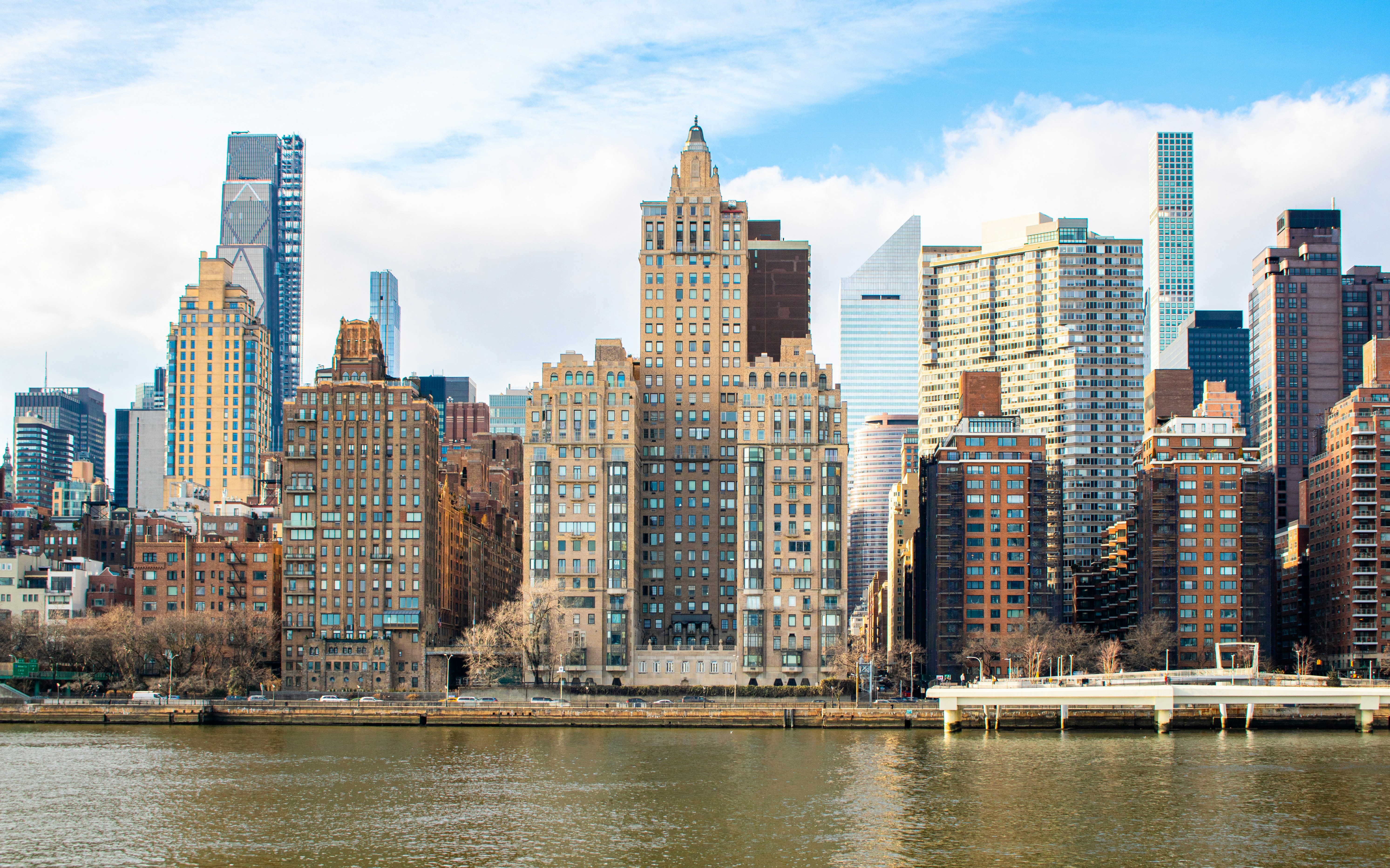 A view of River House (and it's adjacent buildings). It is an iconic 26-story Art Deco co-op at 435 East 52nd Street in Manhattan's Sutton Place. Designed in 1931 by William Lawrence Bottomley, it features a gated cobblestone courtyard with a fountain and once offered residents private yacht access before the FDR Drive was constructed. Known for its exclusivity and storied past—including celebrity rejections and legal battles—River House remains one of NYC's most prestigious addresses, embodying old-world luxury along the East River.