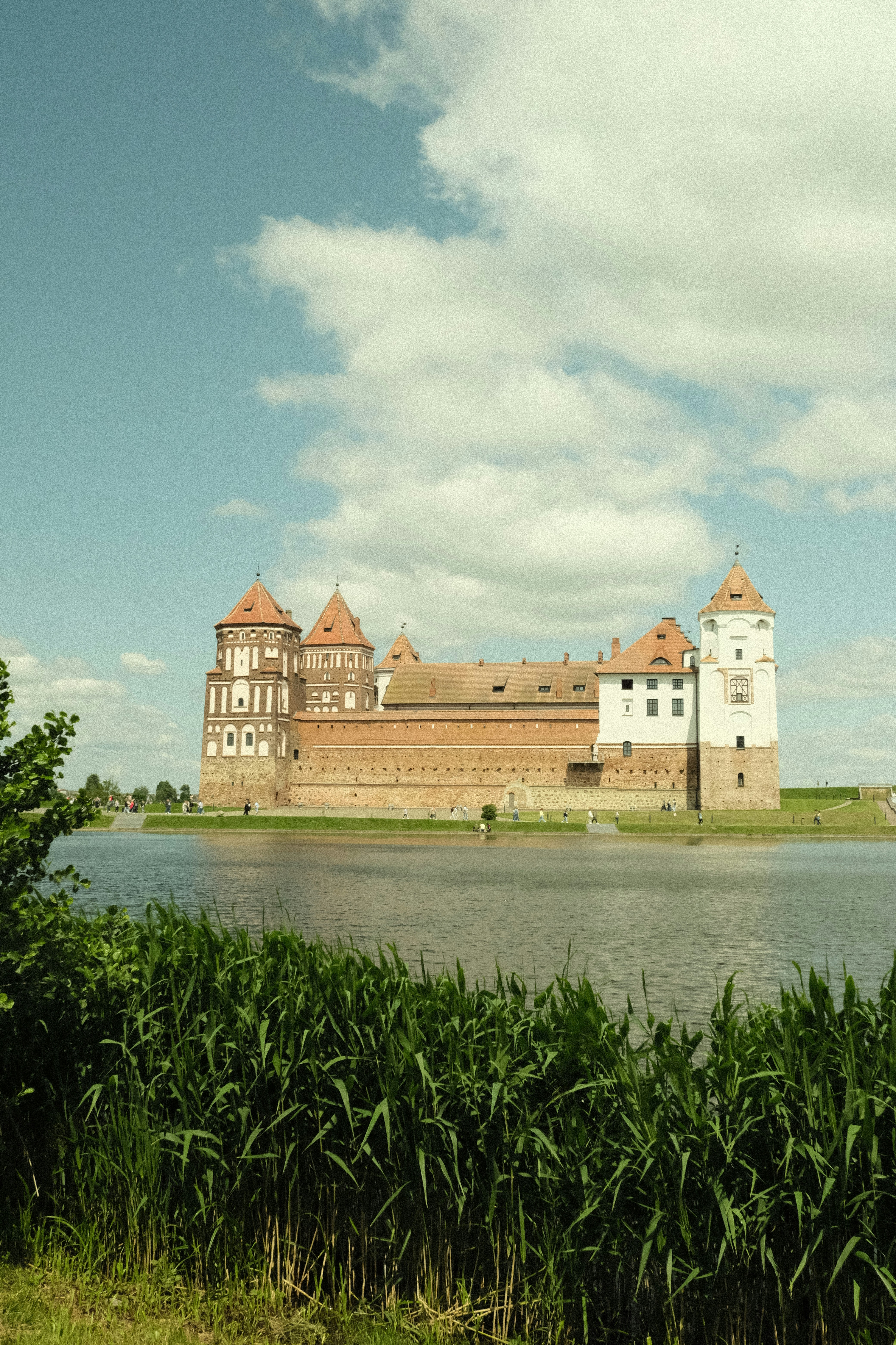 A majestic castle is next to the water.