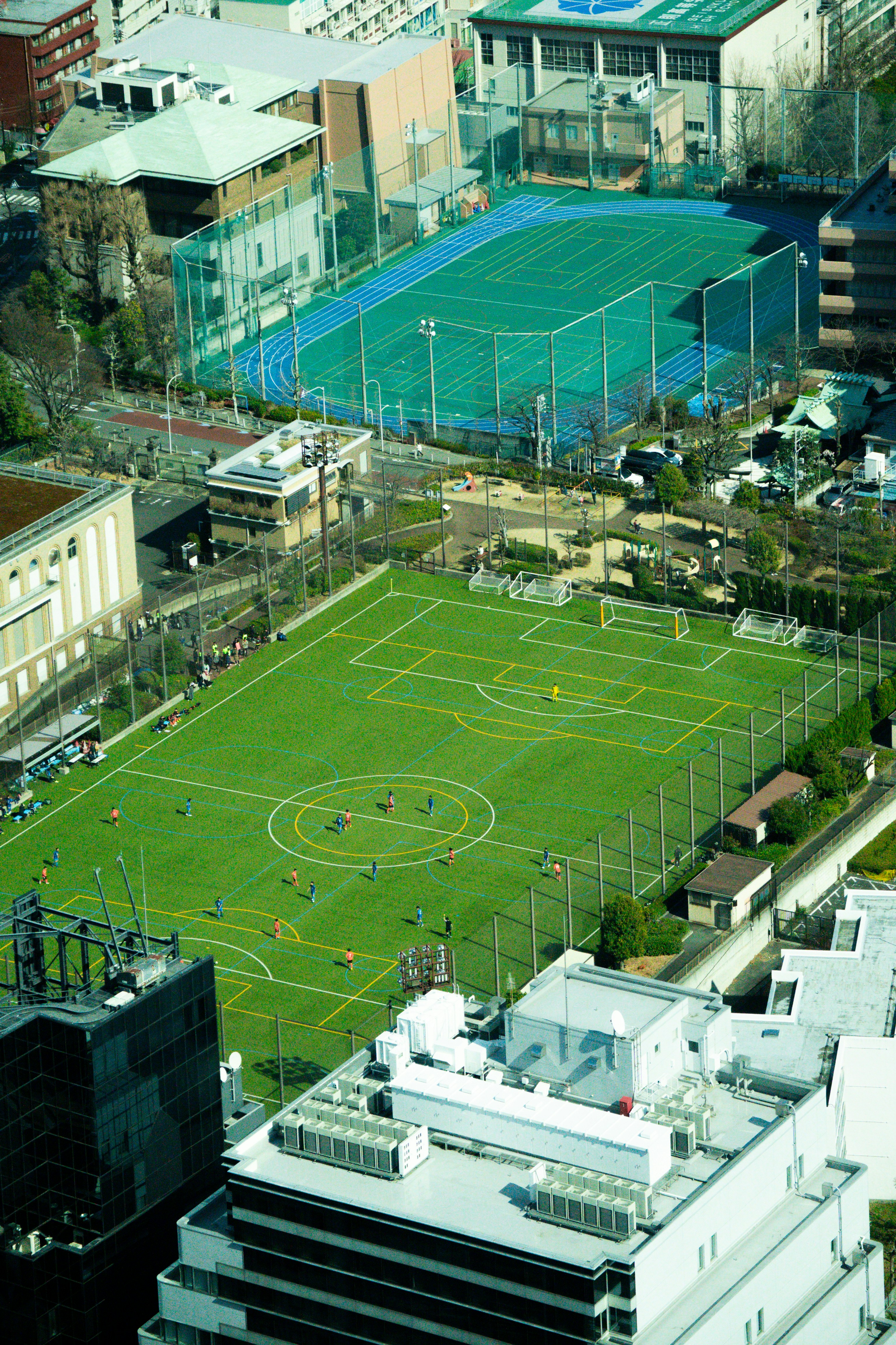 Blue Court Over the City: Aerial View of a Compact Multi-Sport Complex