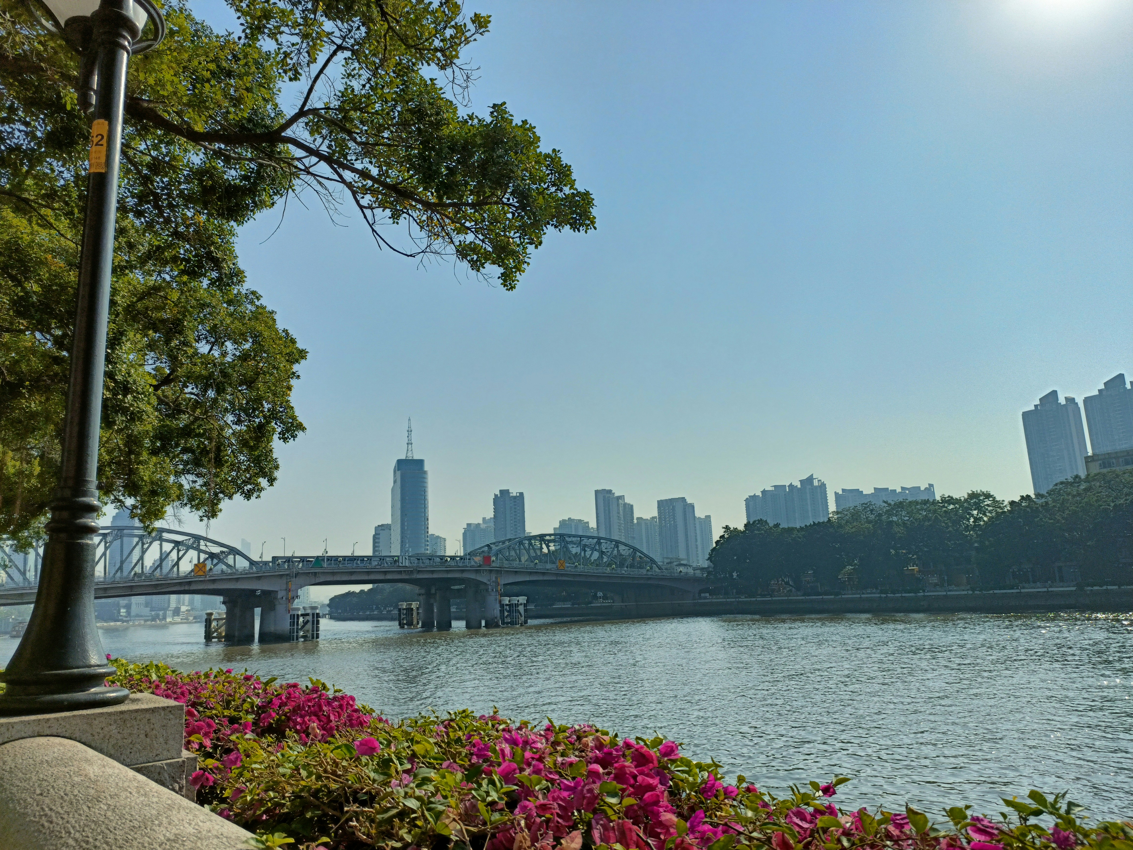 A riverside cityscape with buildings and a bridge. photo – Free ...