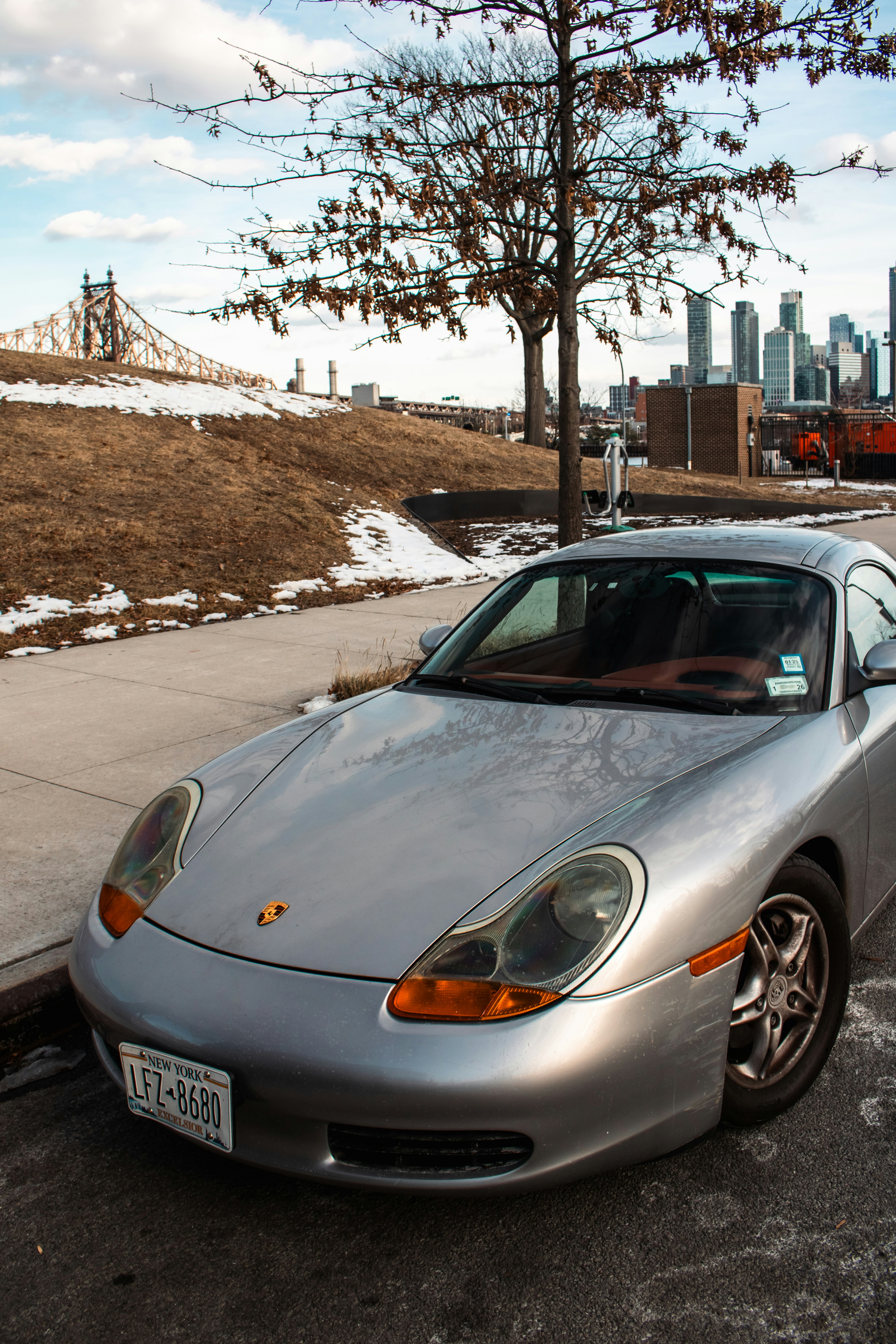 Silver Porsche by the Park: Echoes of City and Road