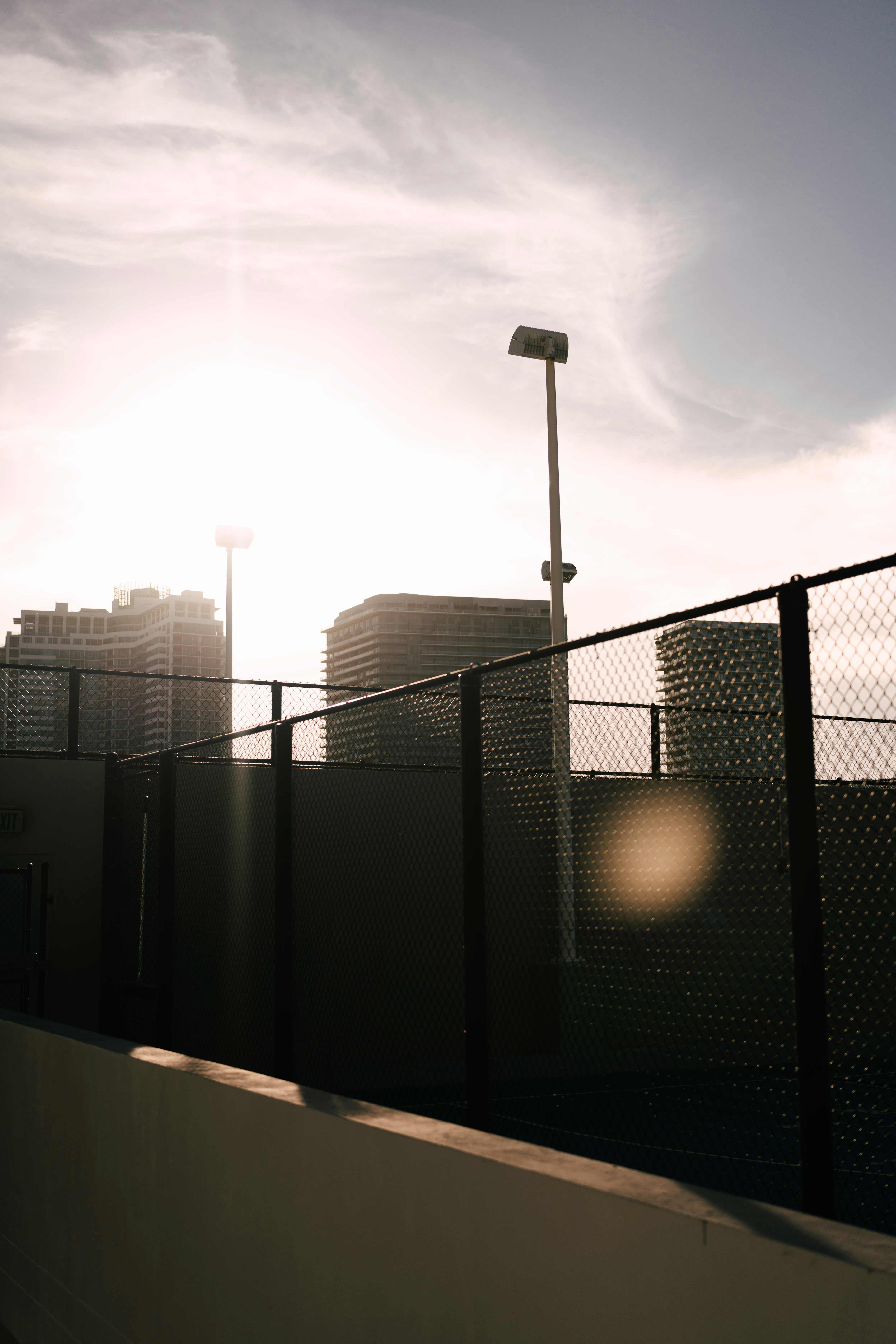 Buildings are silhouetted against the bright sun.