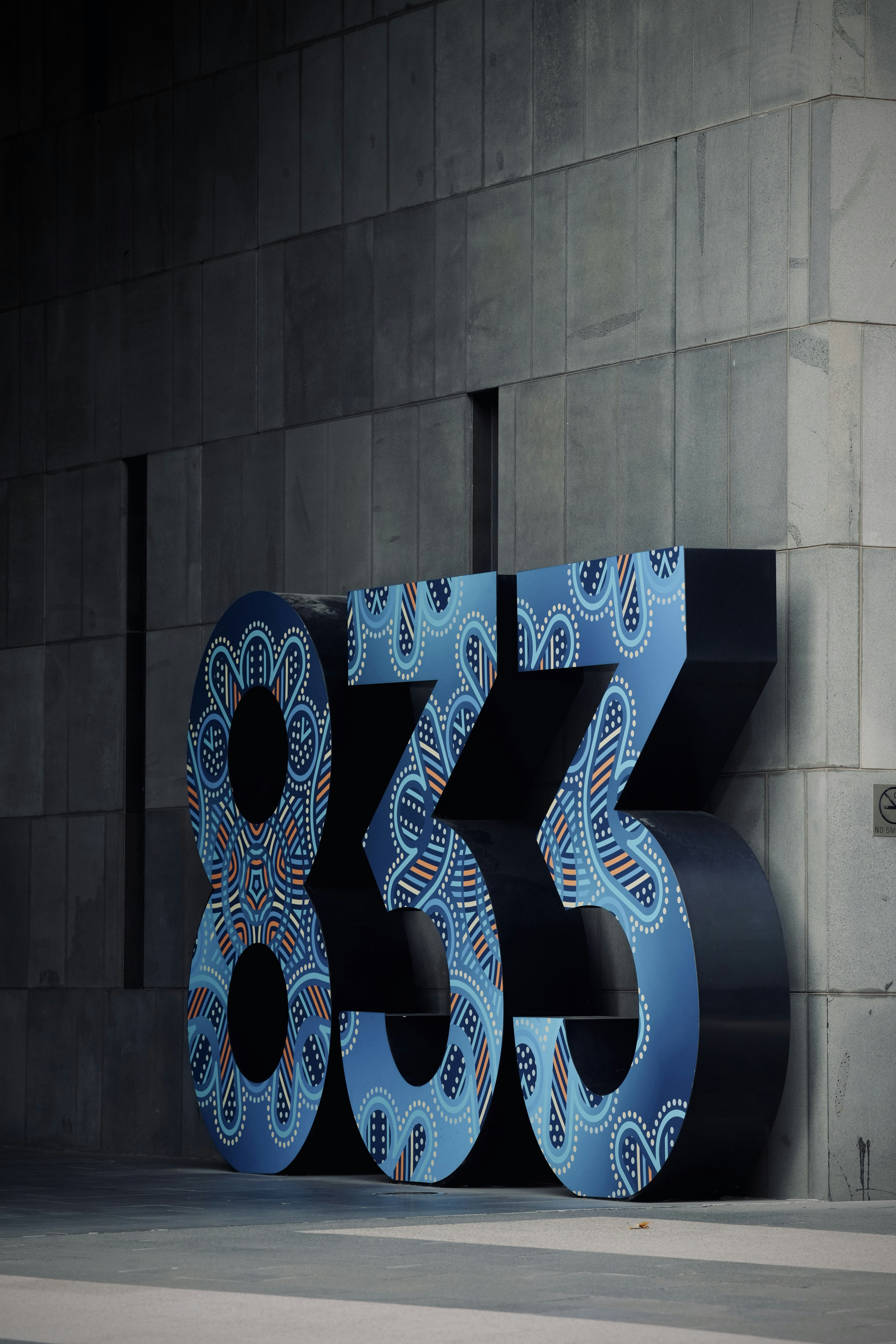 Blue Paisley Numbers: An Urban Sculpture Under Concrete Skies