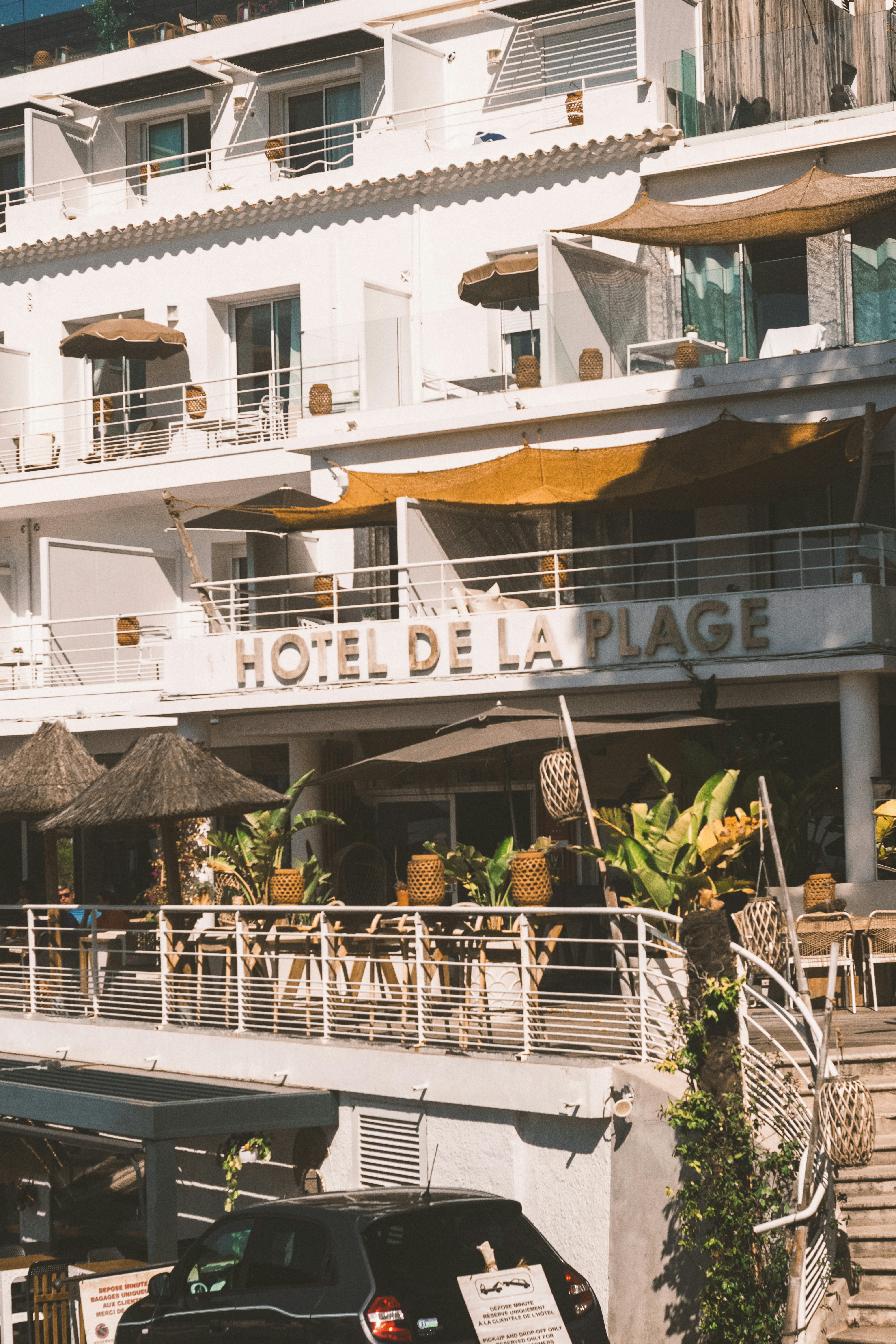 Sunlit Hotel de la Plage: Balconies, Awnings, and a Sea of Tables