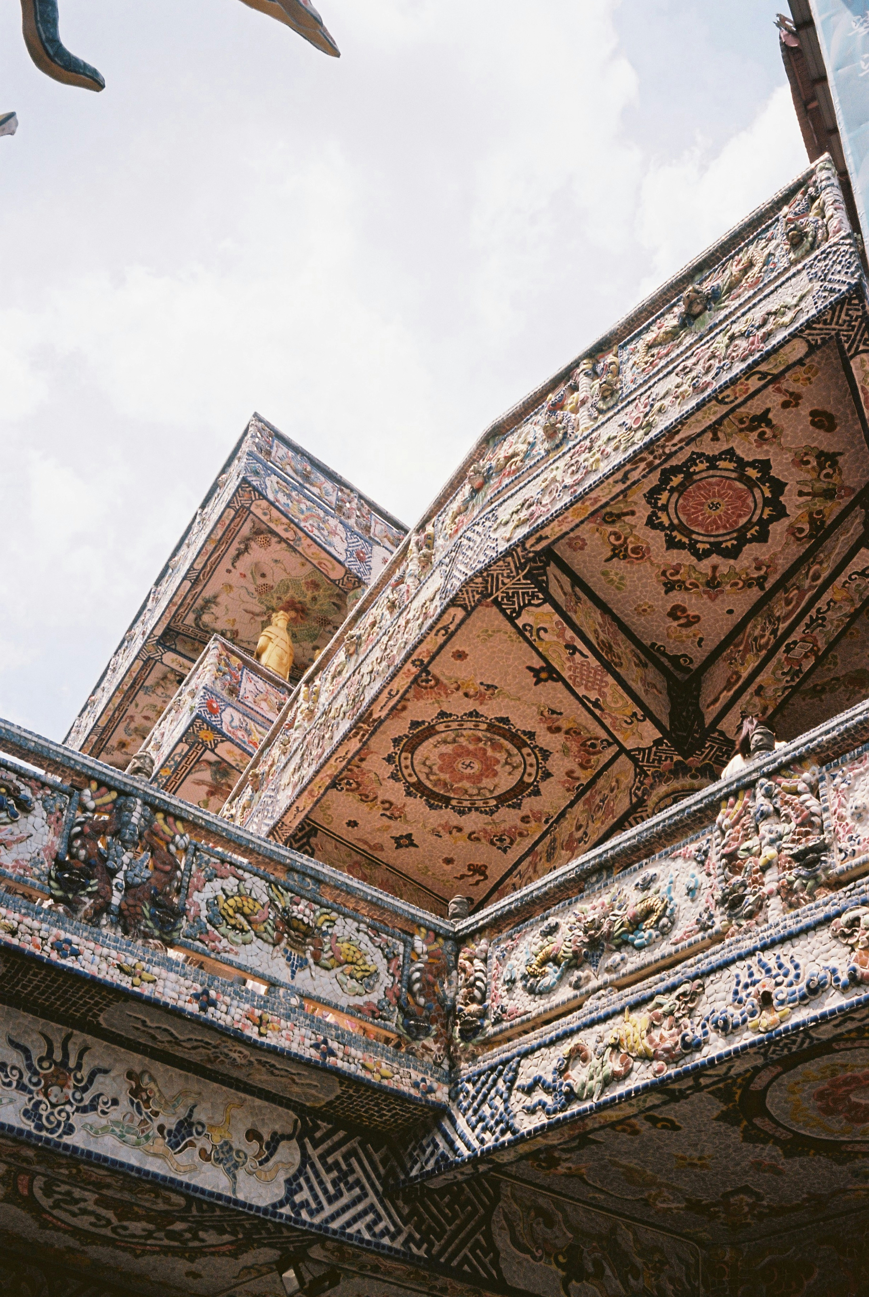 Intricate detailing of a multi-level structure adorned with vibrant murals and sculptures, showcasing a blend of cultural artistry.