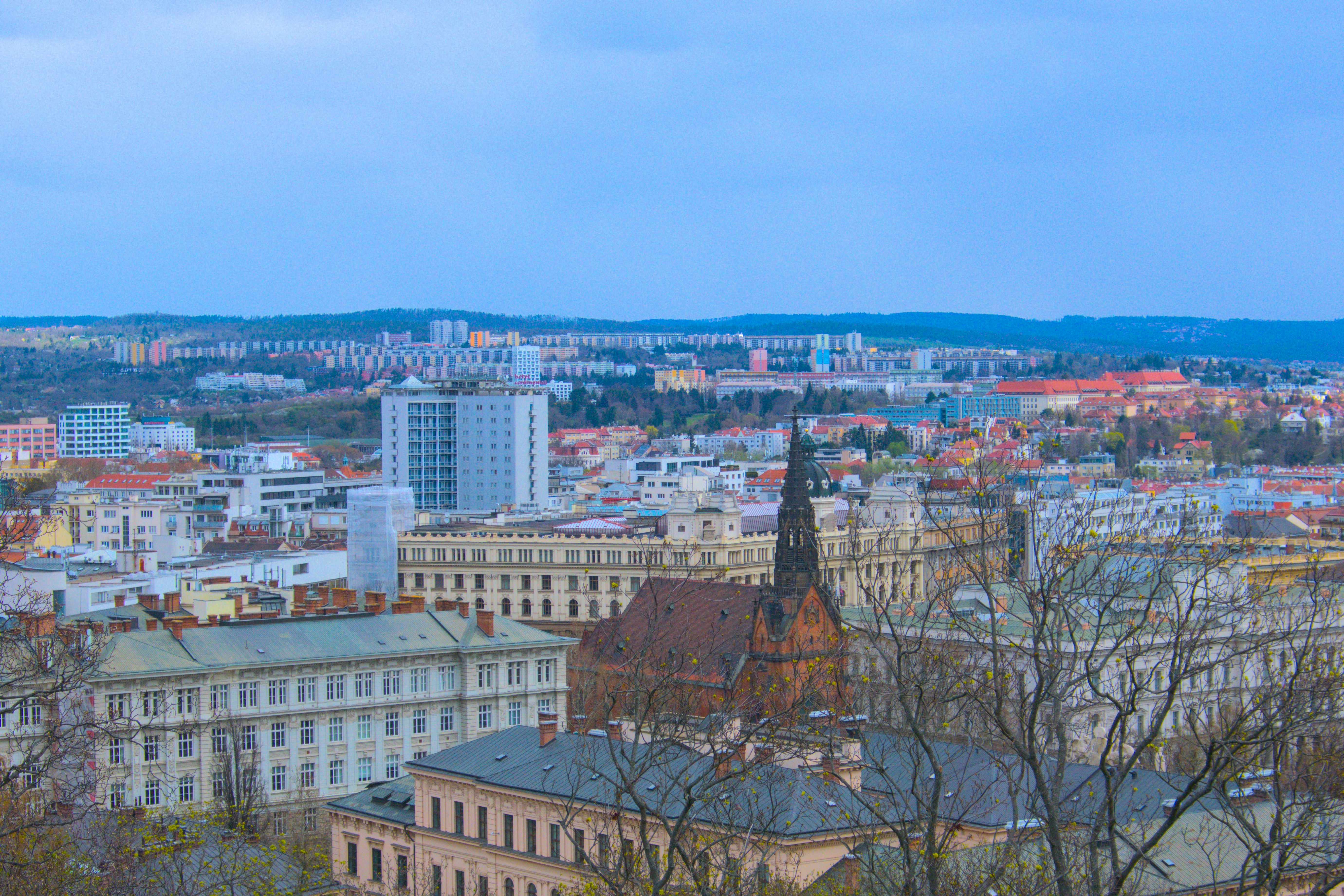 Cityscape view featuring buildings under a cloudy sky.