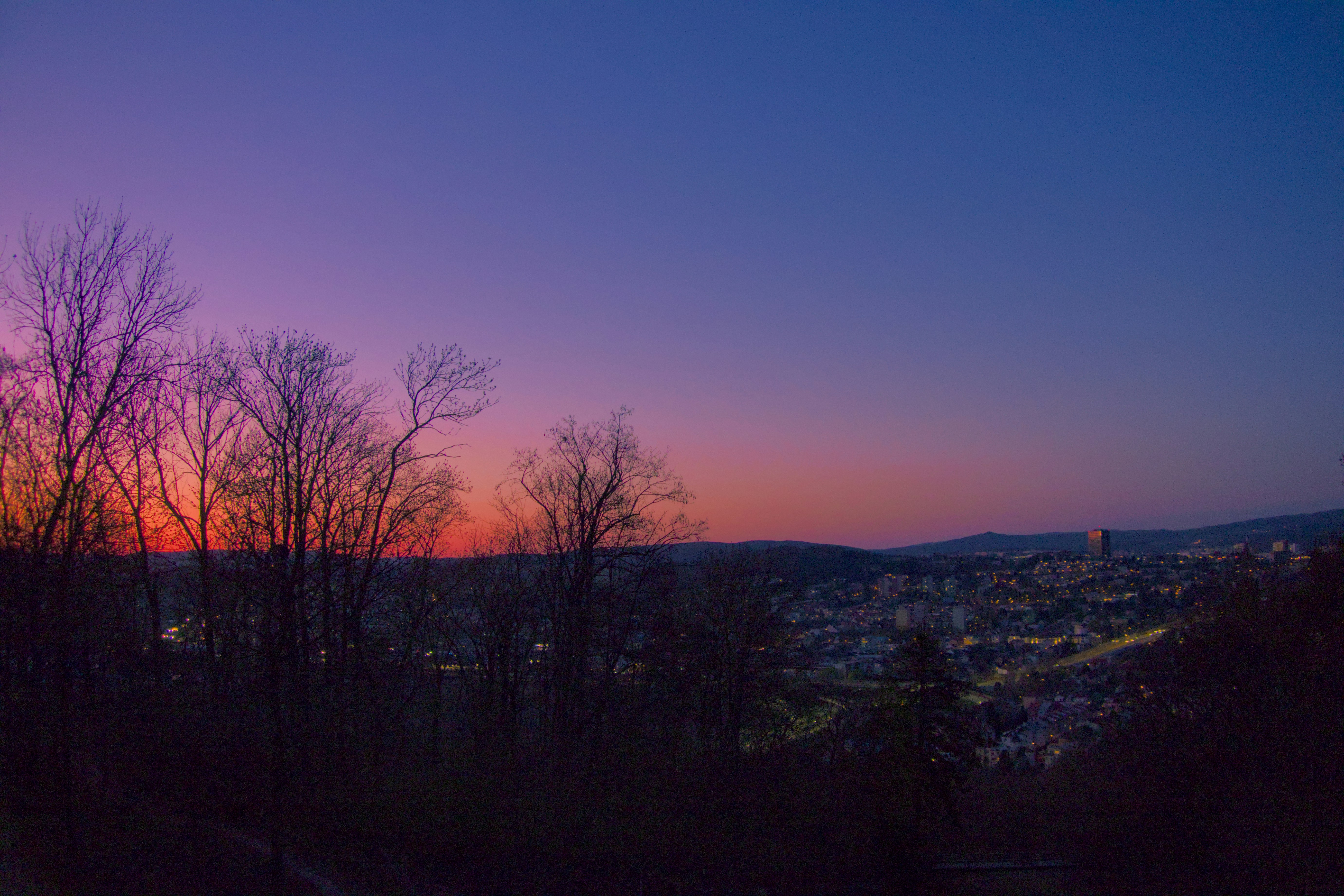 Purple and orange sunset over a city.