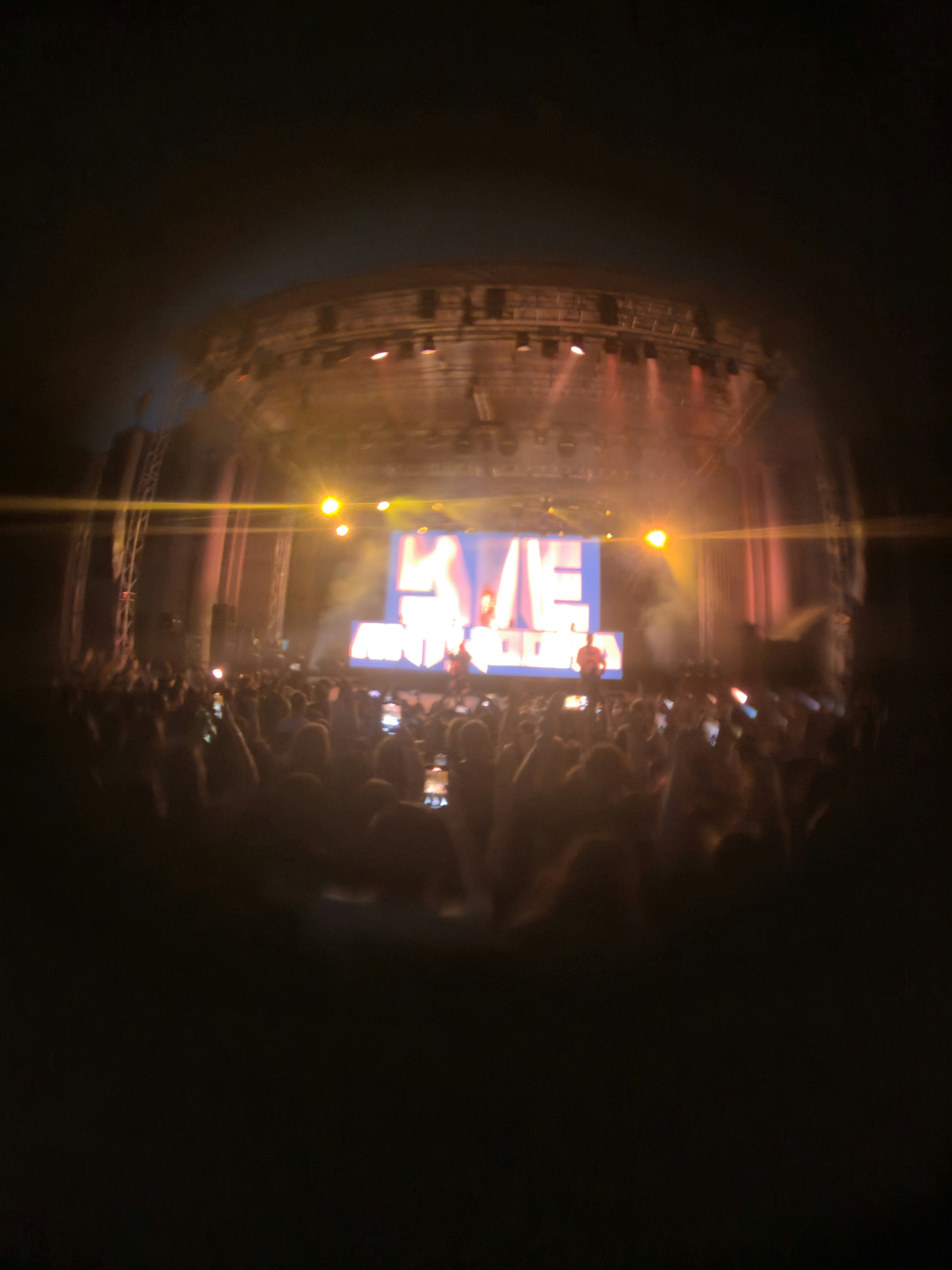 Haloed Stage: Neon Lights Through a Conic View