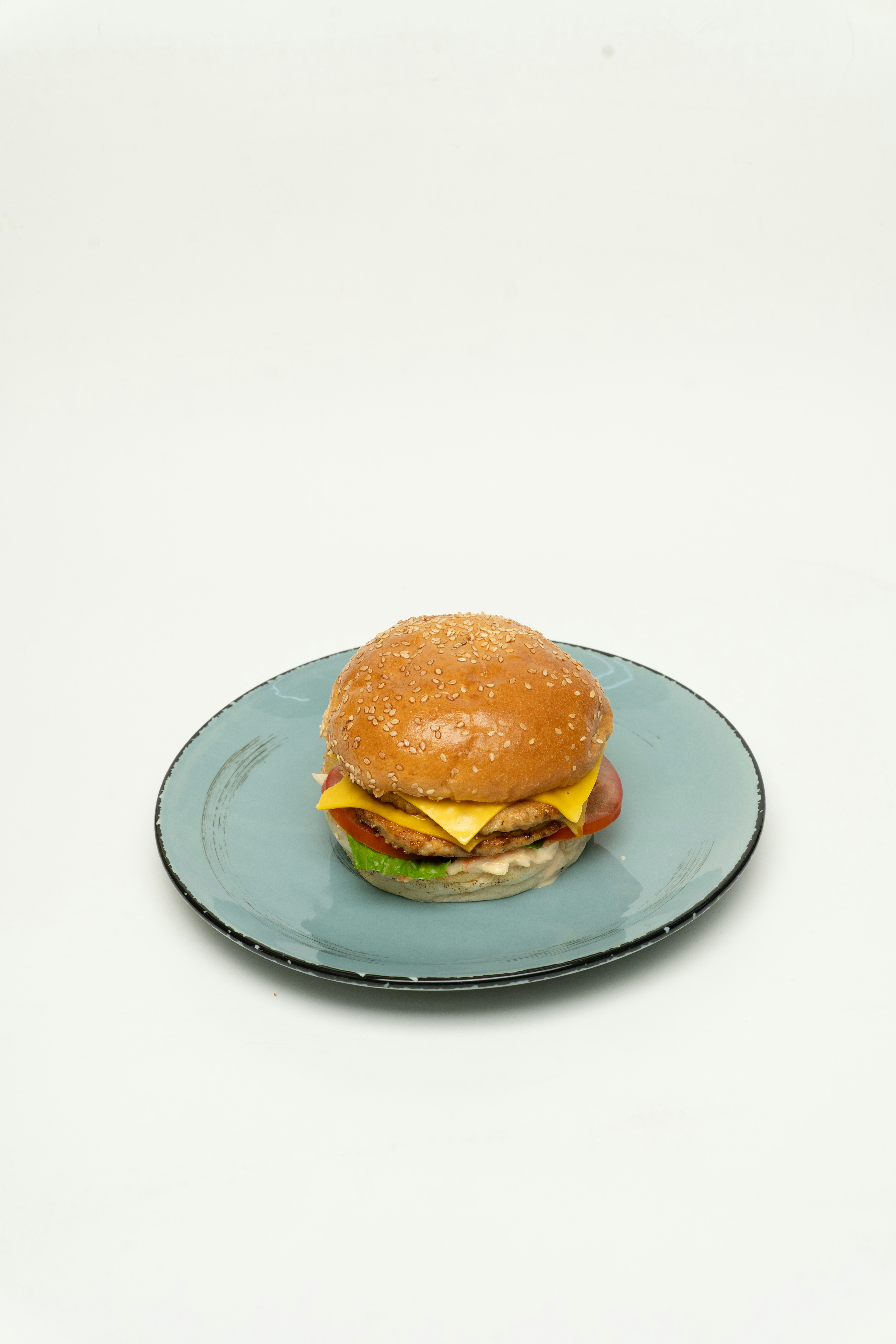 Blue Plate Minimalism: A Hamburger Still Life on a White Studio Stage