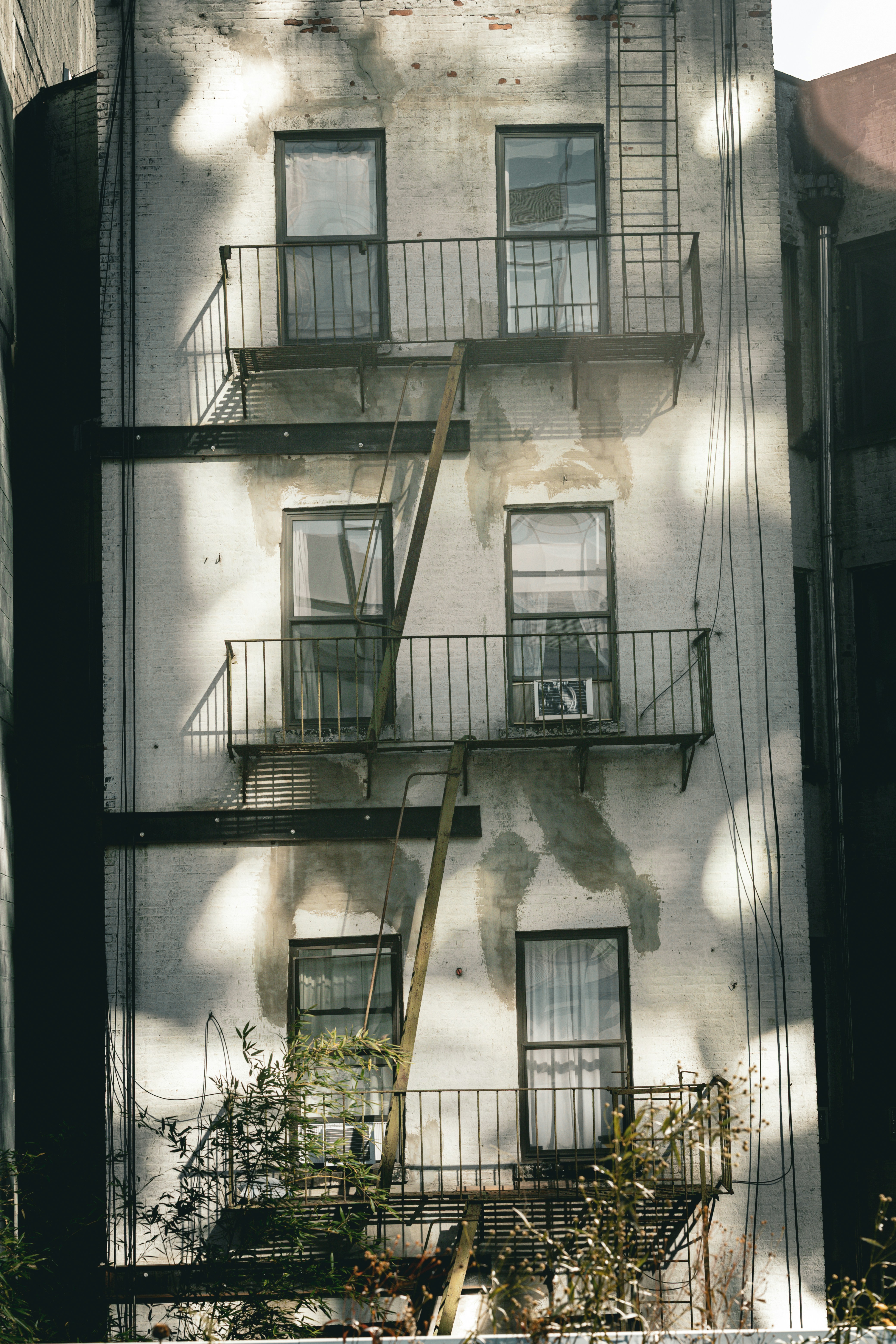 Apartment building with fire escape and balconies.