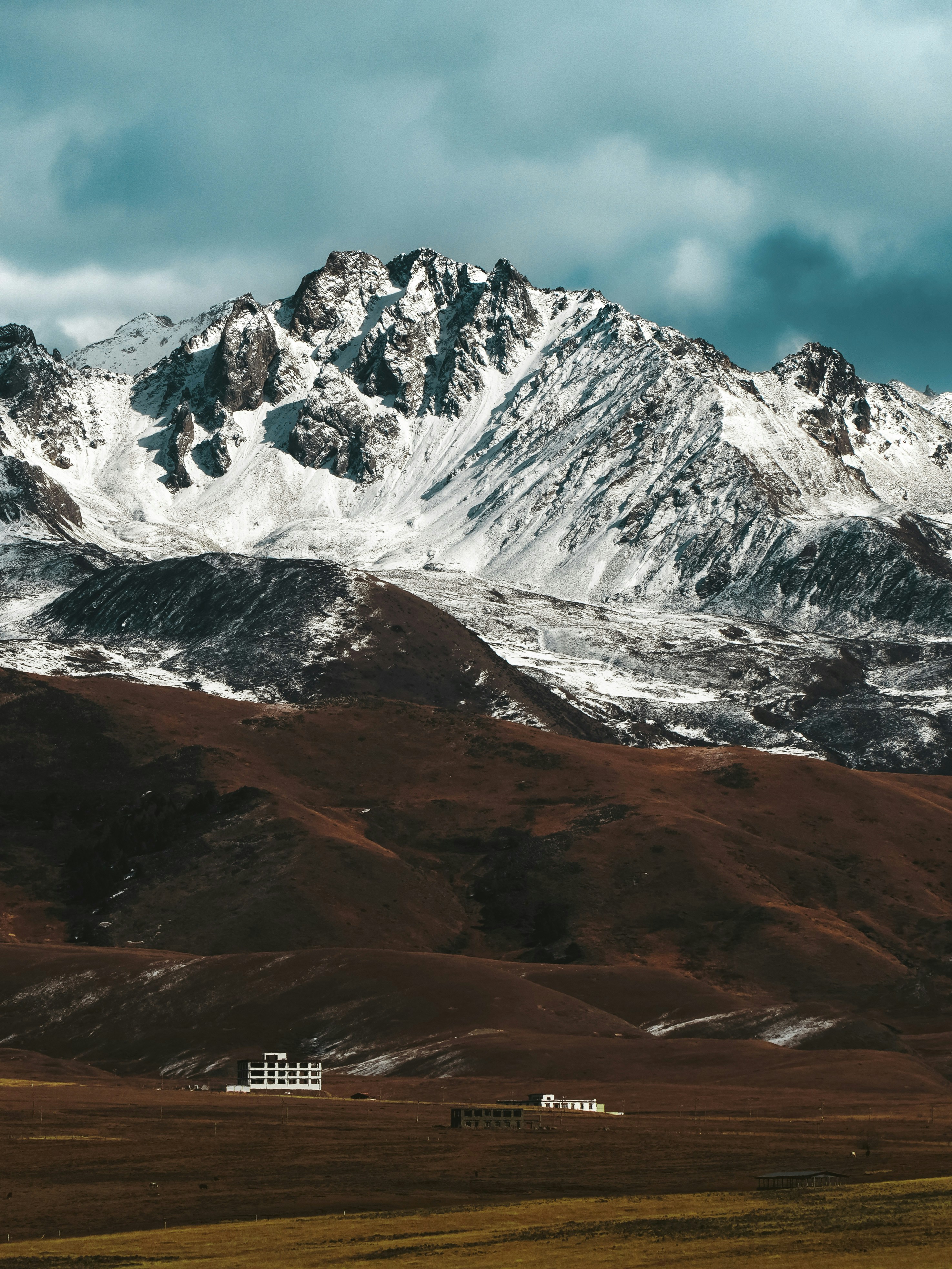 Ridgeline Reverie: Snow-Clad Peaks Over a Quiet Valley