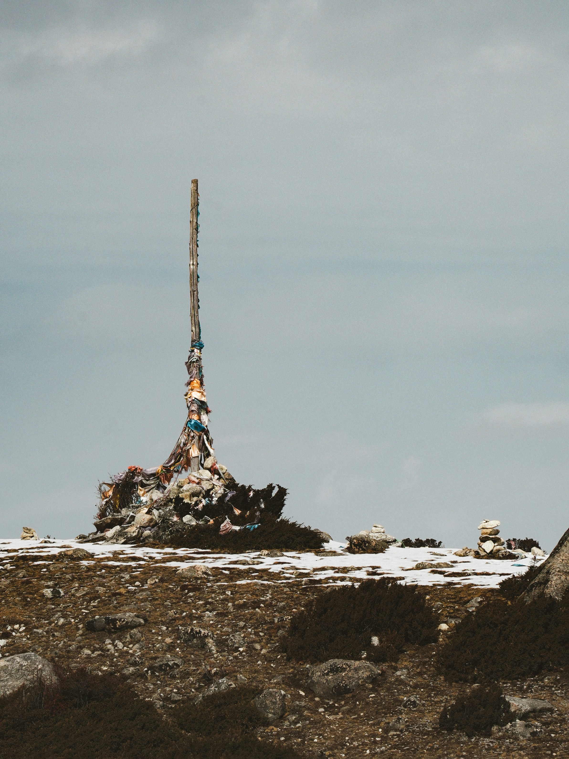 A Prayer Flag Spire Rises on a Snow-Kissed Shore