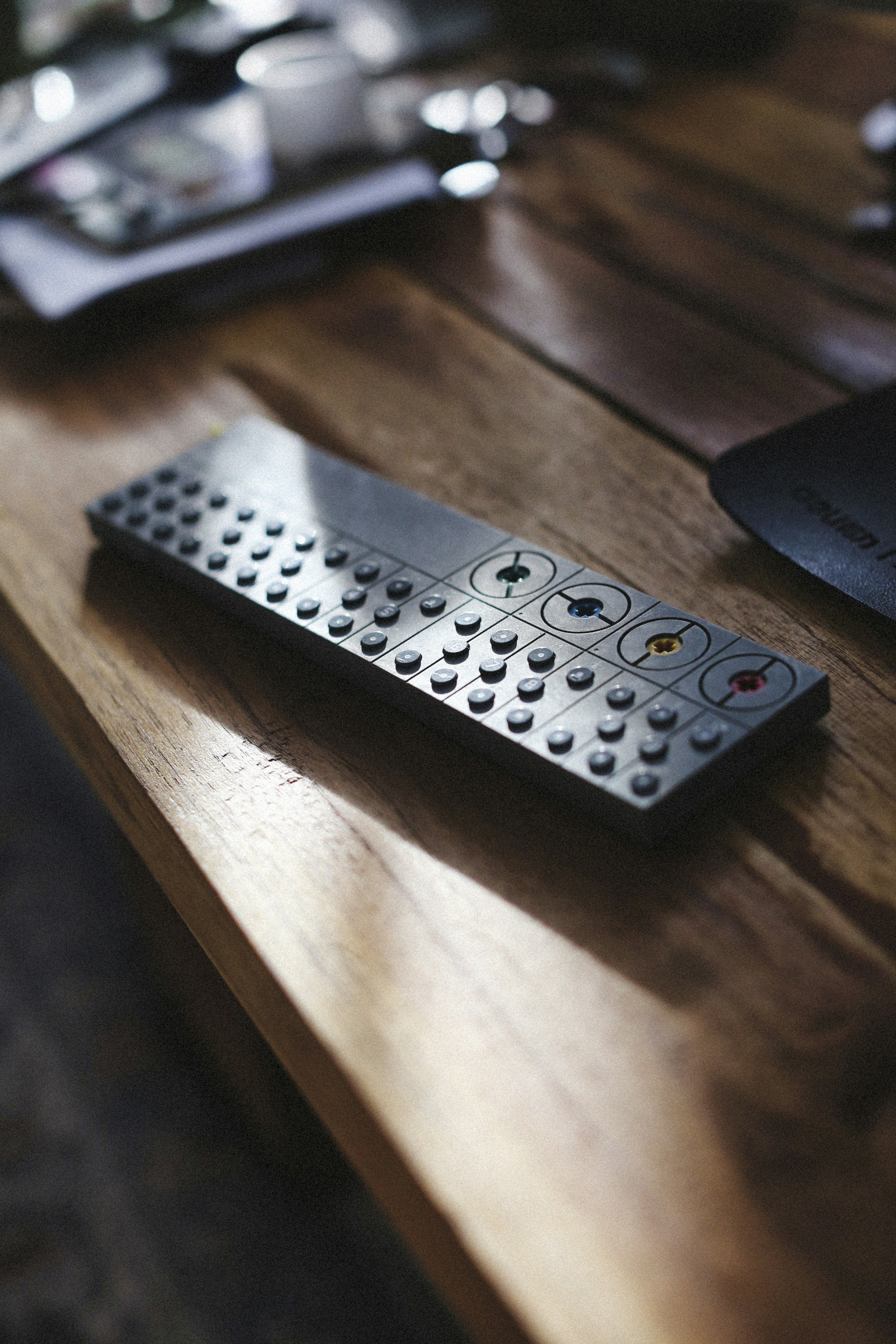 Lego-style remote resting along the sunlit wooden table