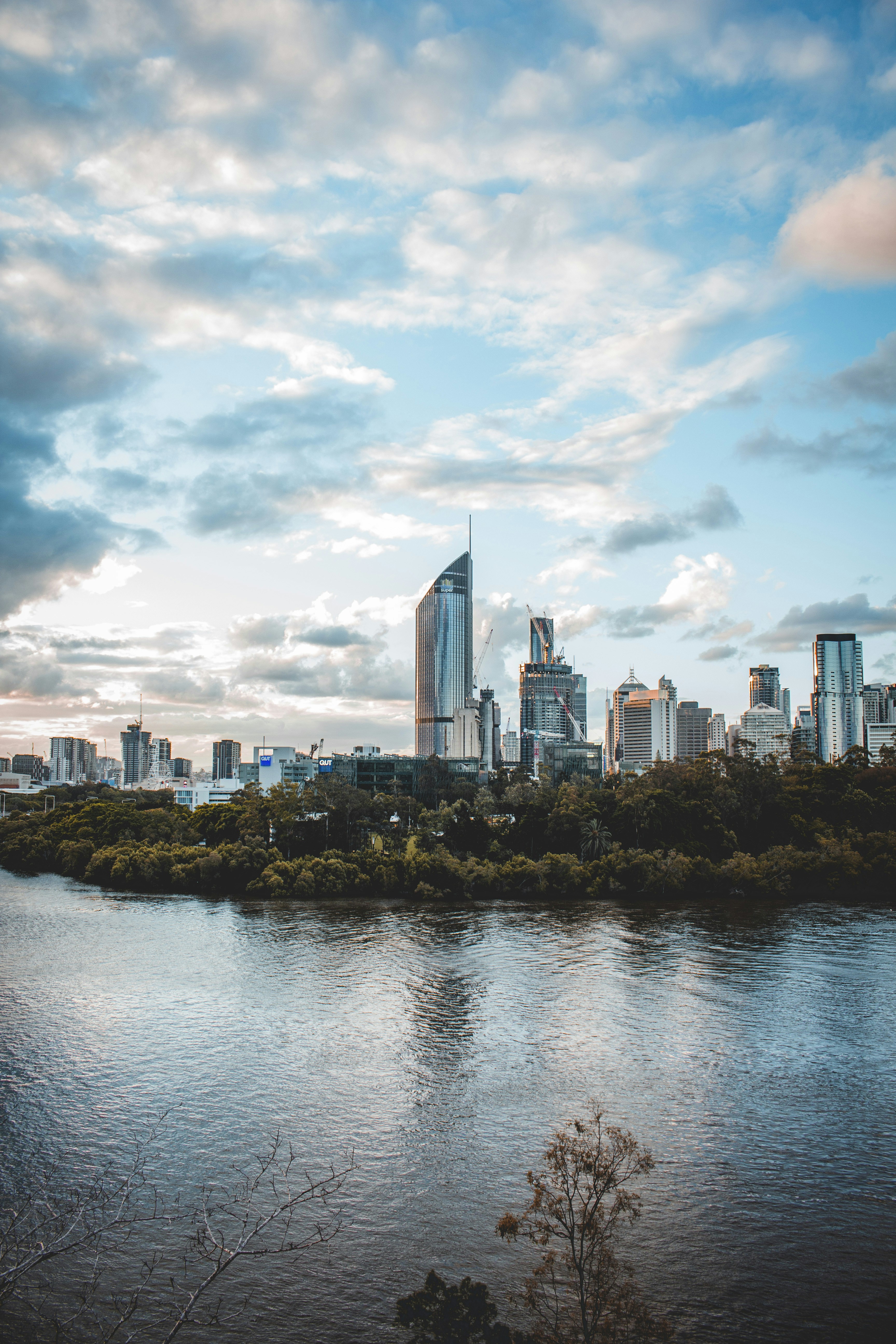 Brisbane | A city skyline reflects on a calm river.