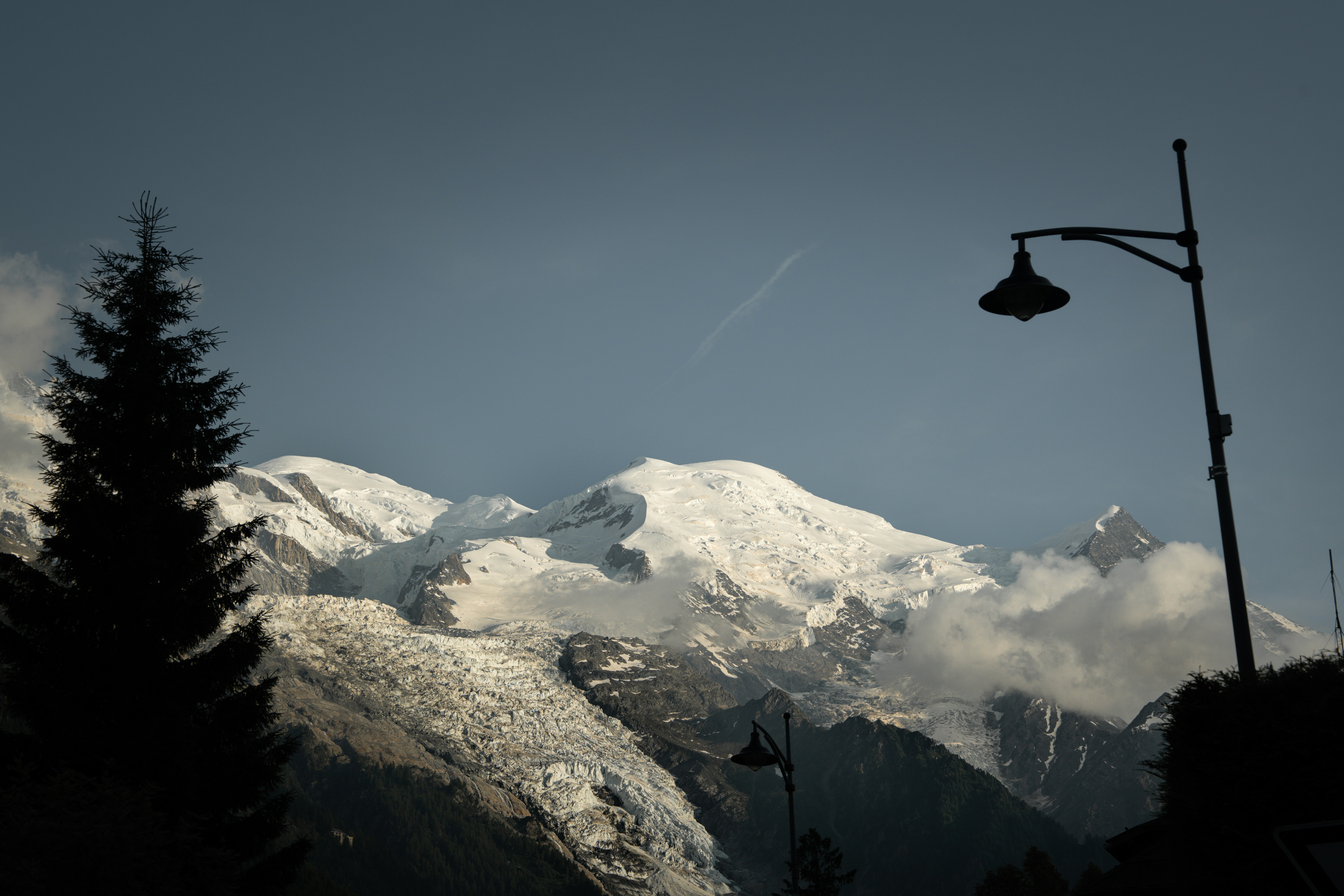 Snowbound Peak Framed by a Lone Streetlamp and Pines