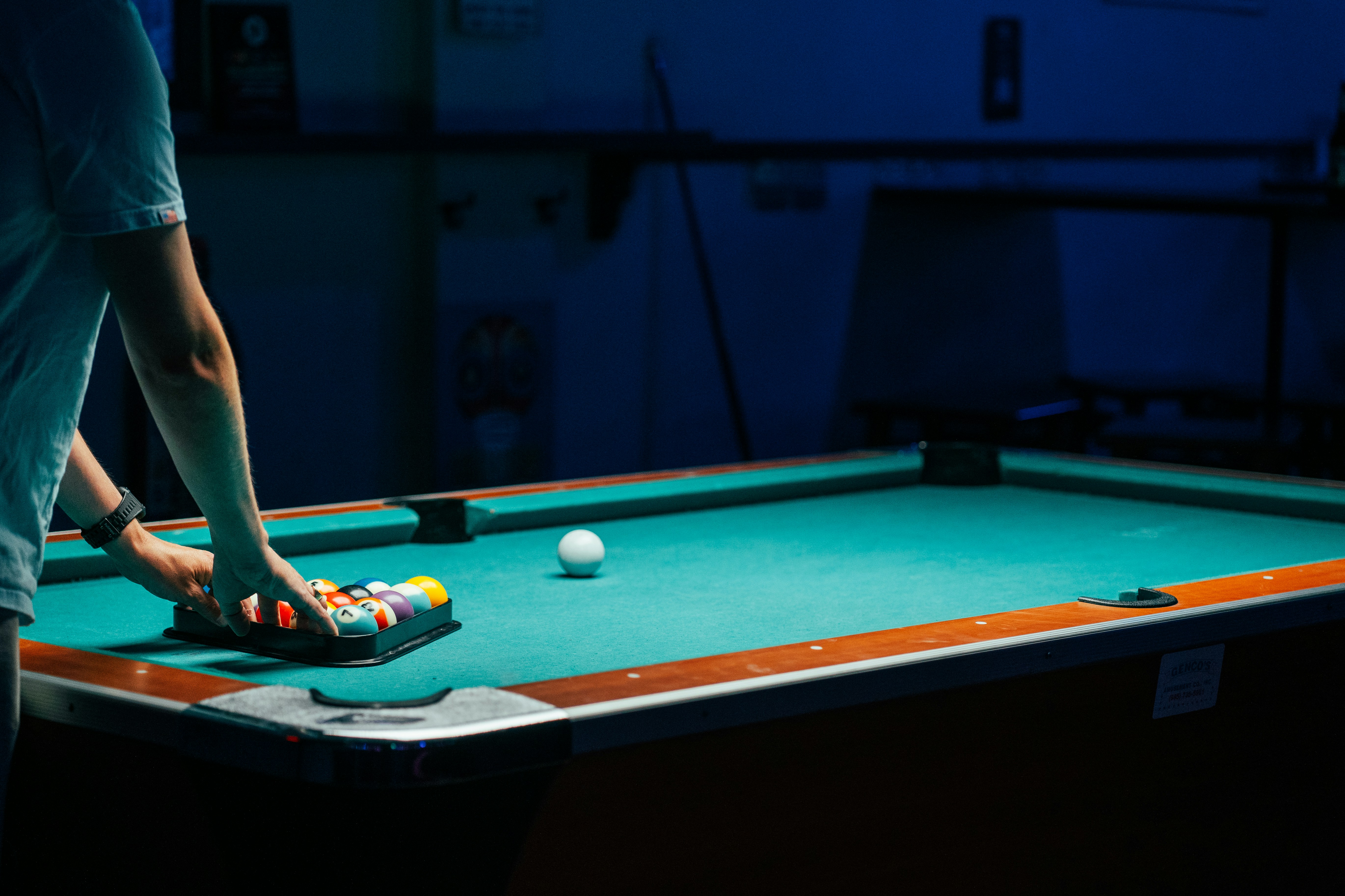 Pool Table, Billiards | A person is setting up to play pool.