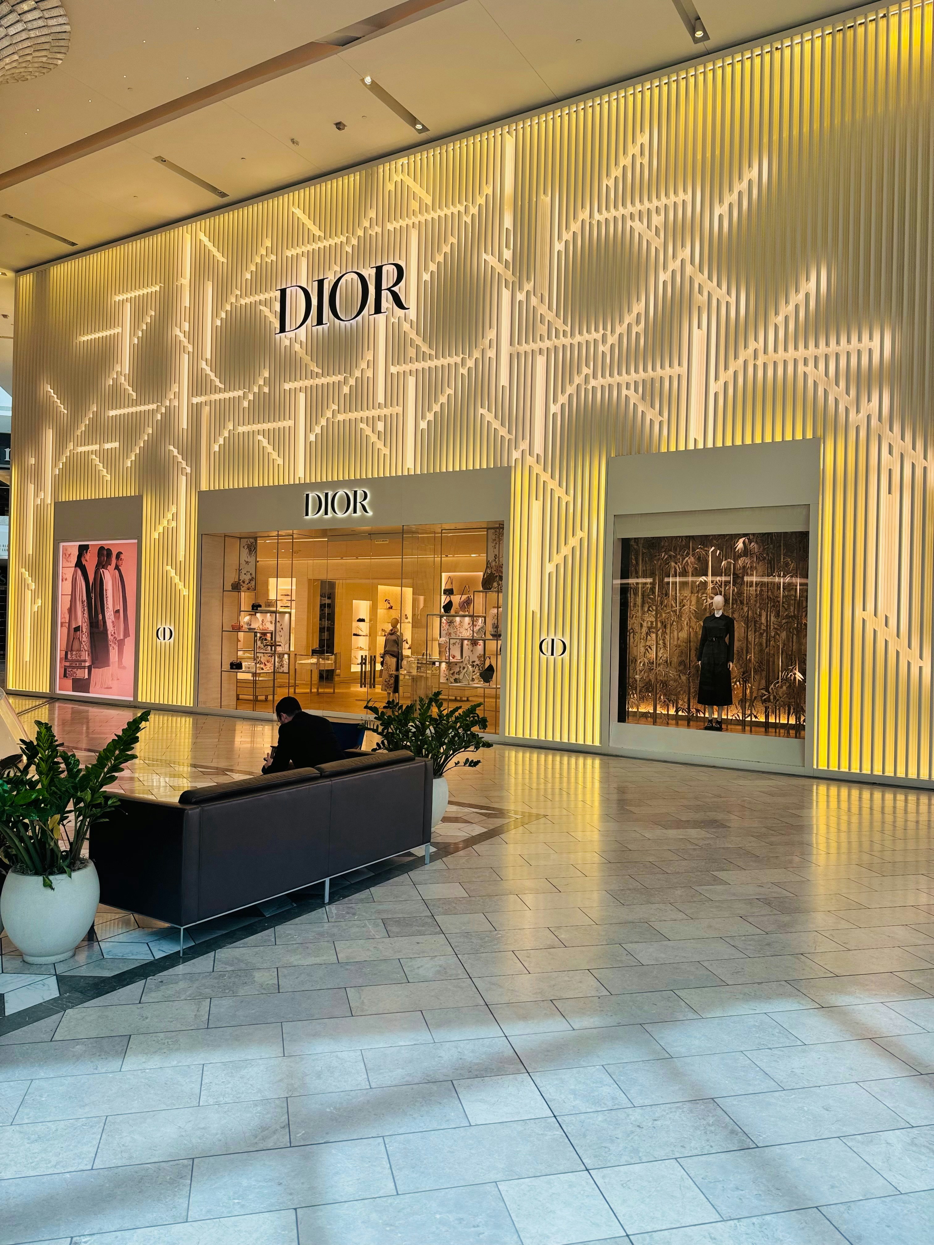 A dior storefront displays bright lighting and decor. photo – Free ...