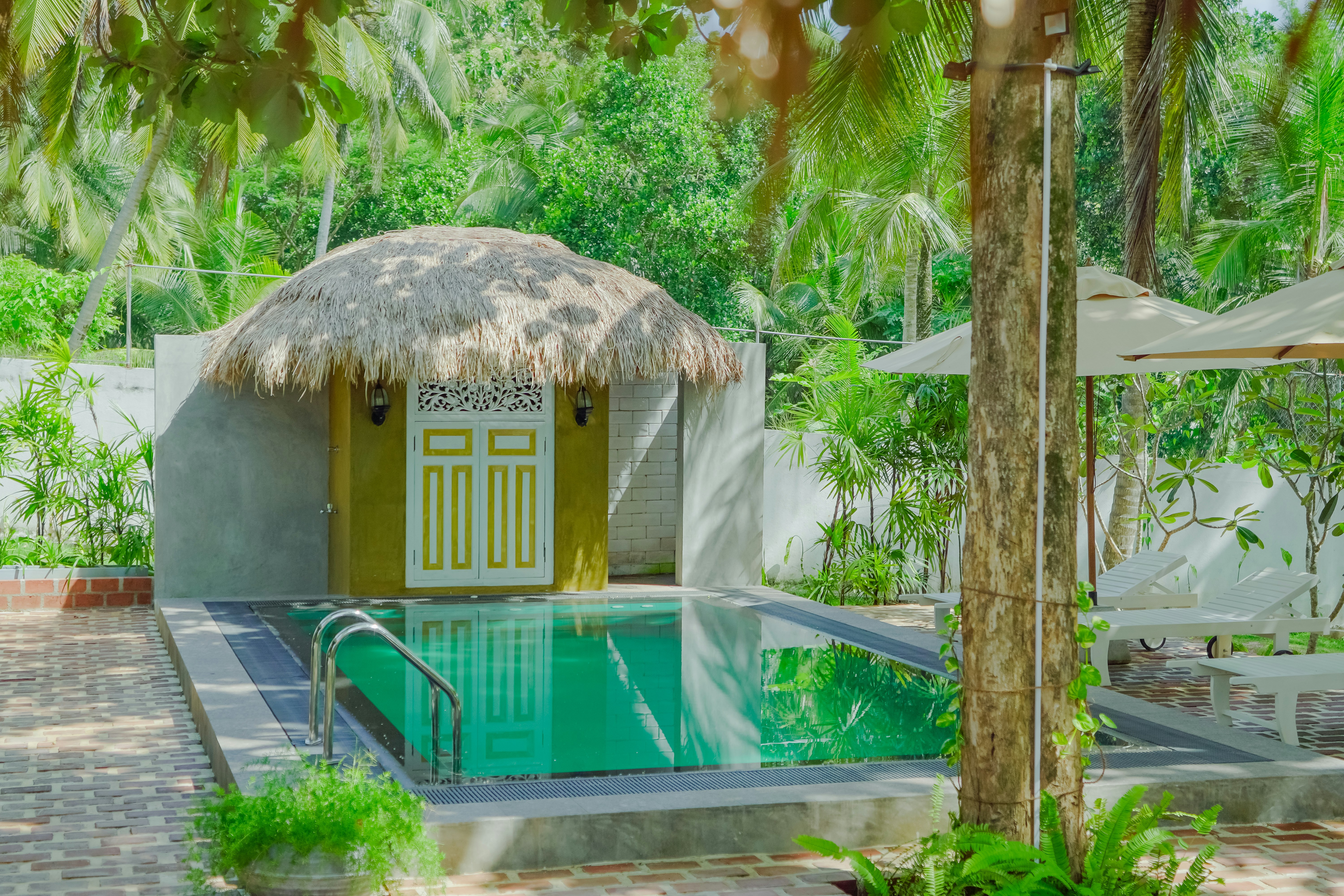 A swimming pool next to a hut. photo – Free Tropical paradise Image on ...