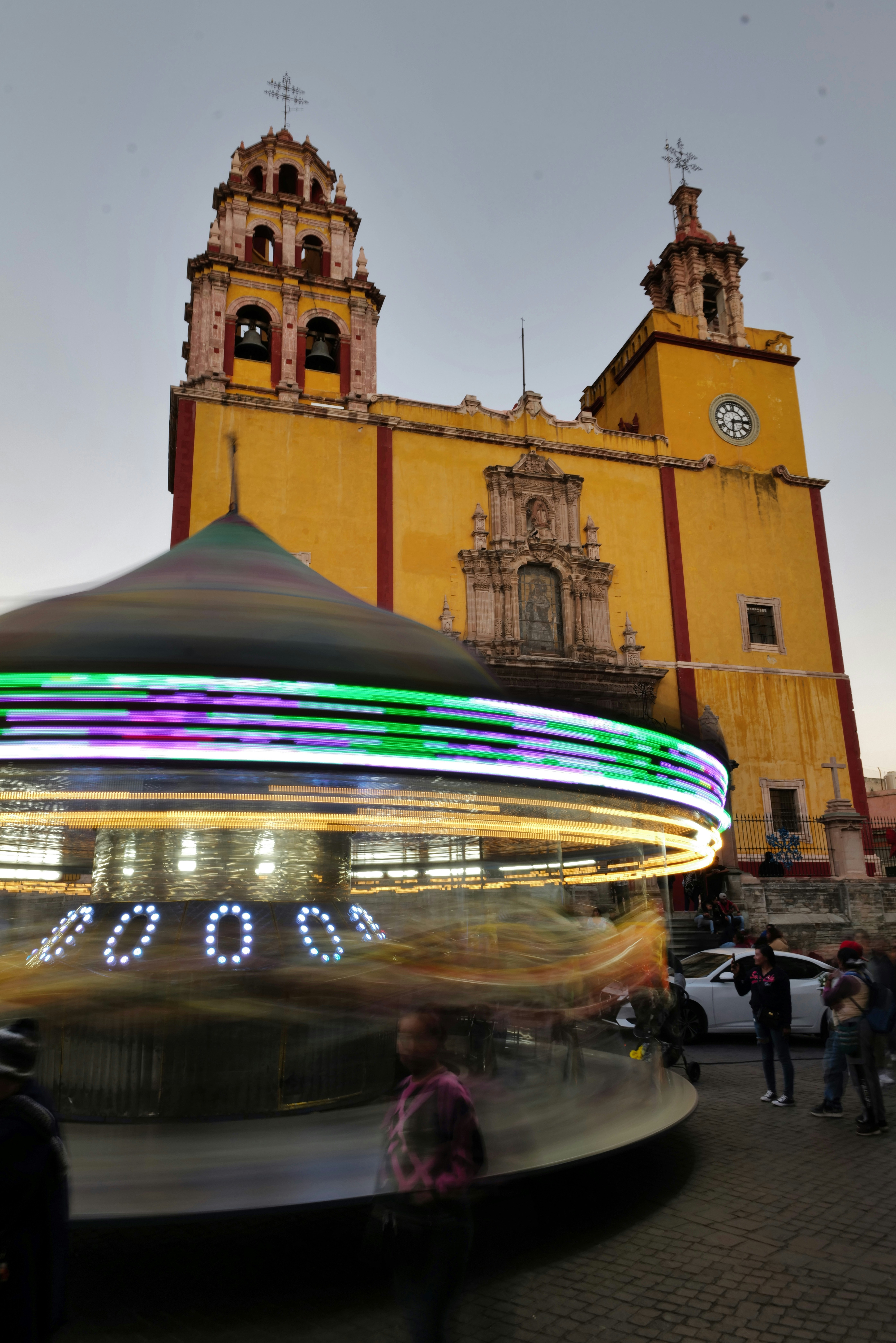 Whirling Lights Against Historic Facades