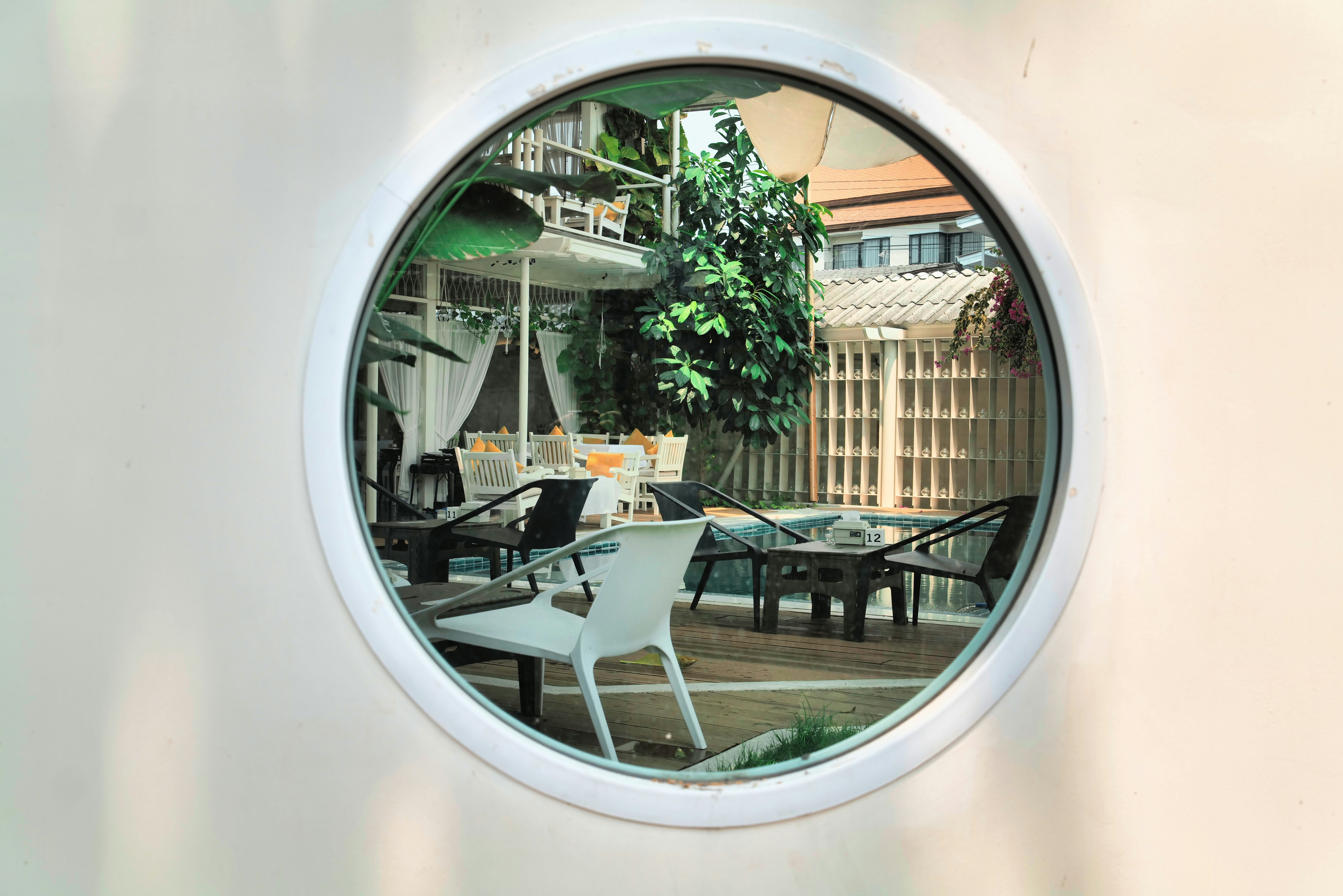 Circular Window to a Quiet Courtyard Café