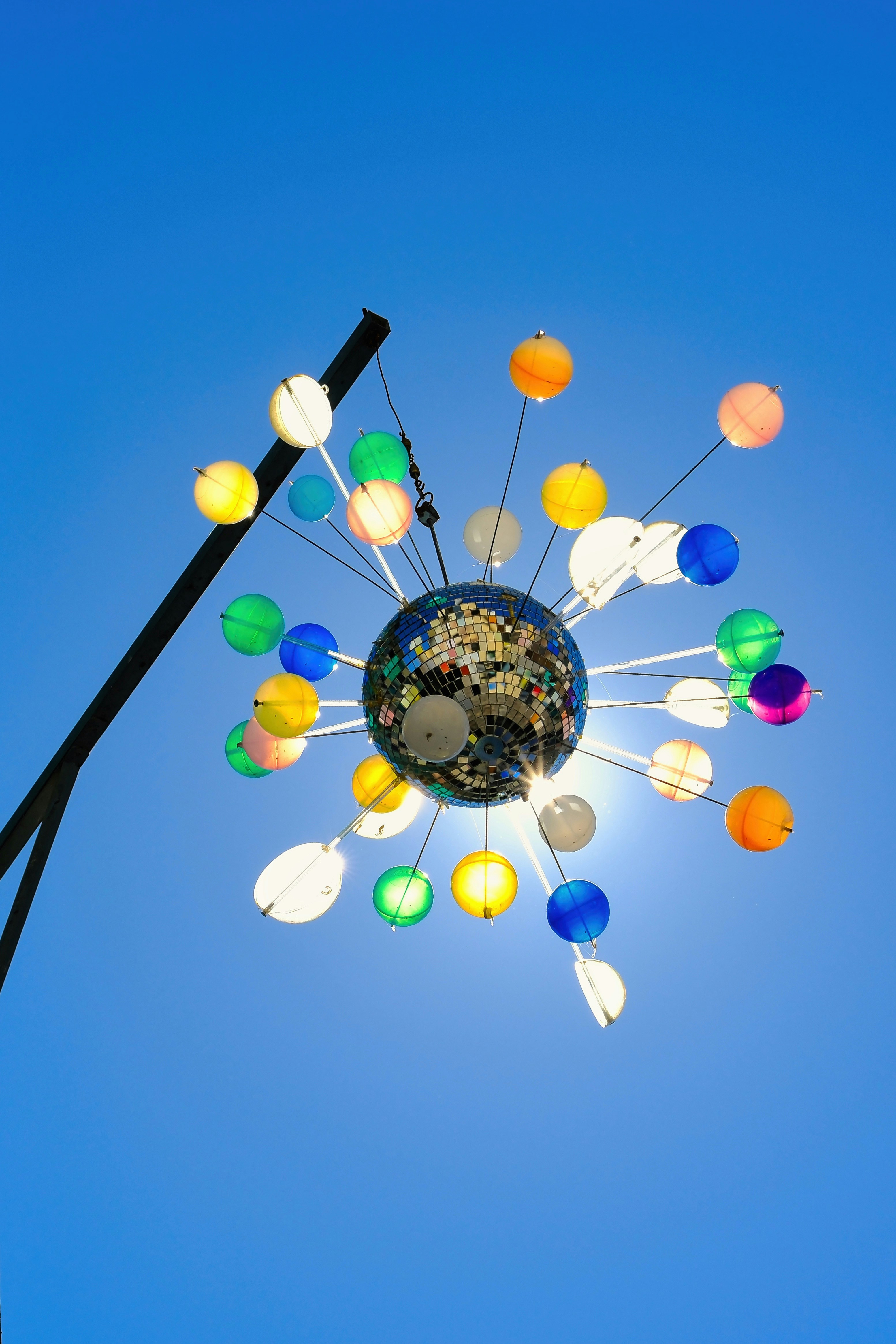 A colorful globe ornate against the bright blue sky.