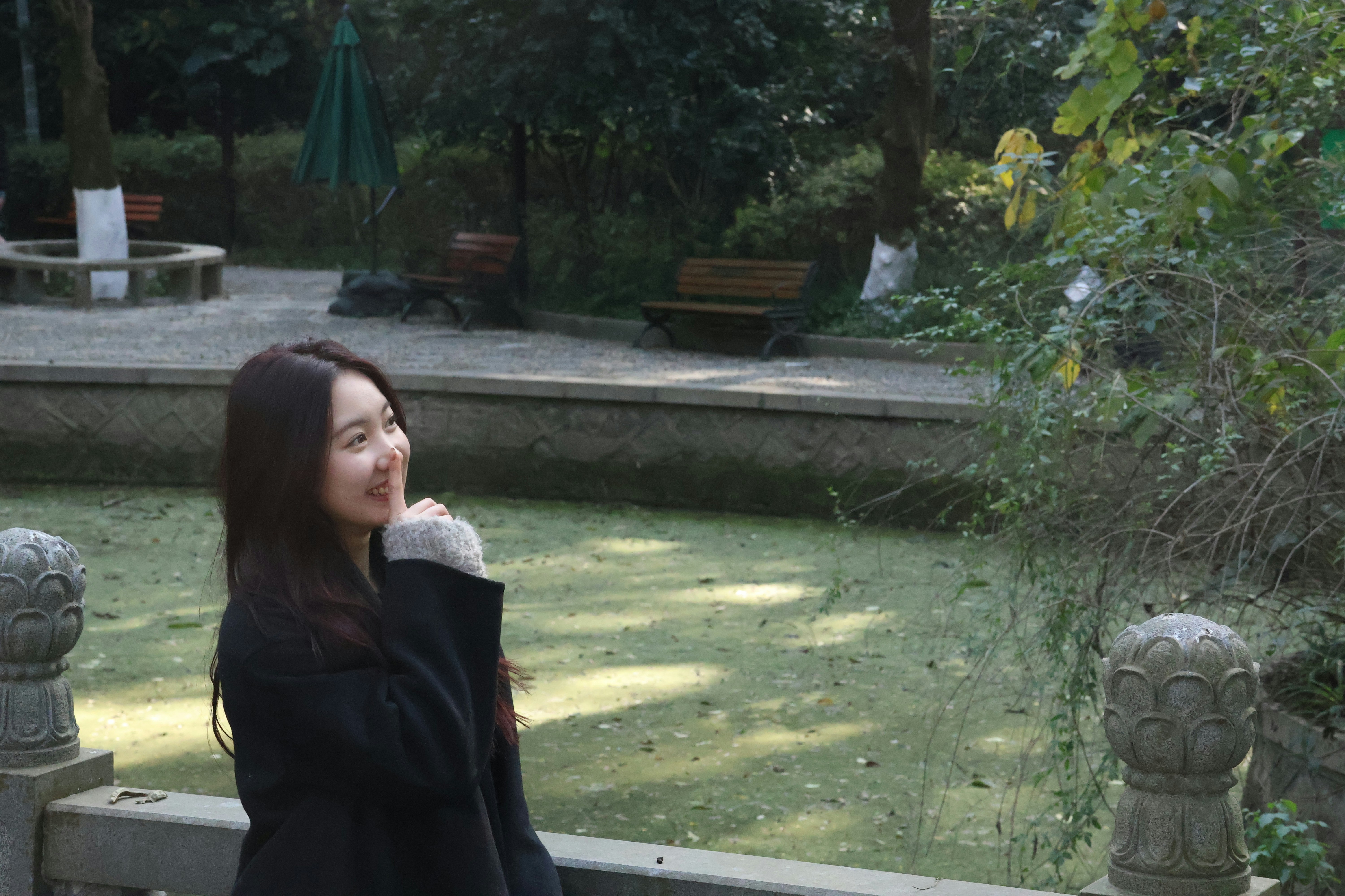 Soft Focus at the Park: Woman in Black by Stone Railings
