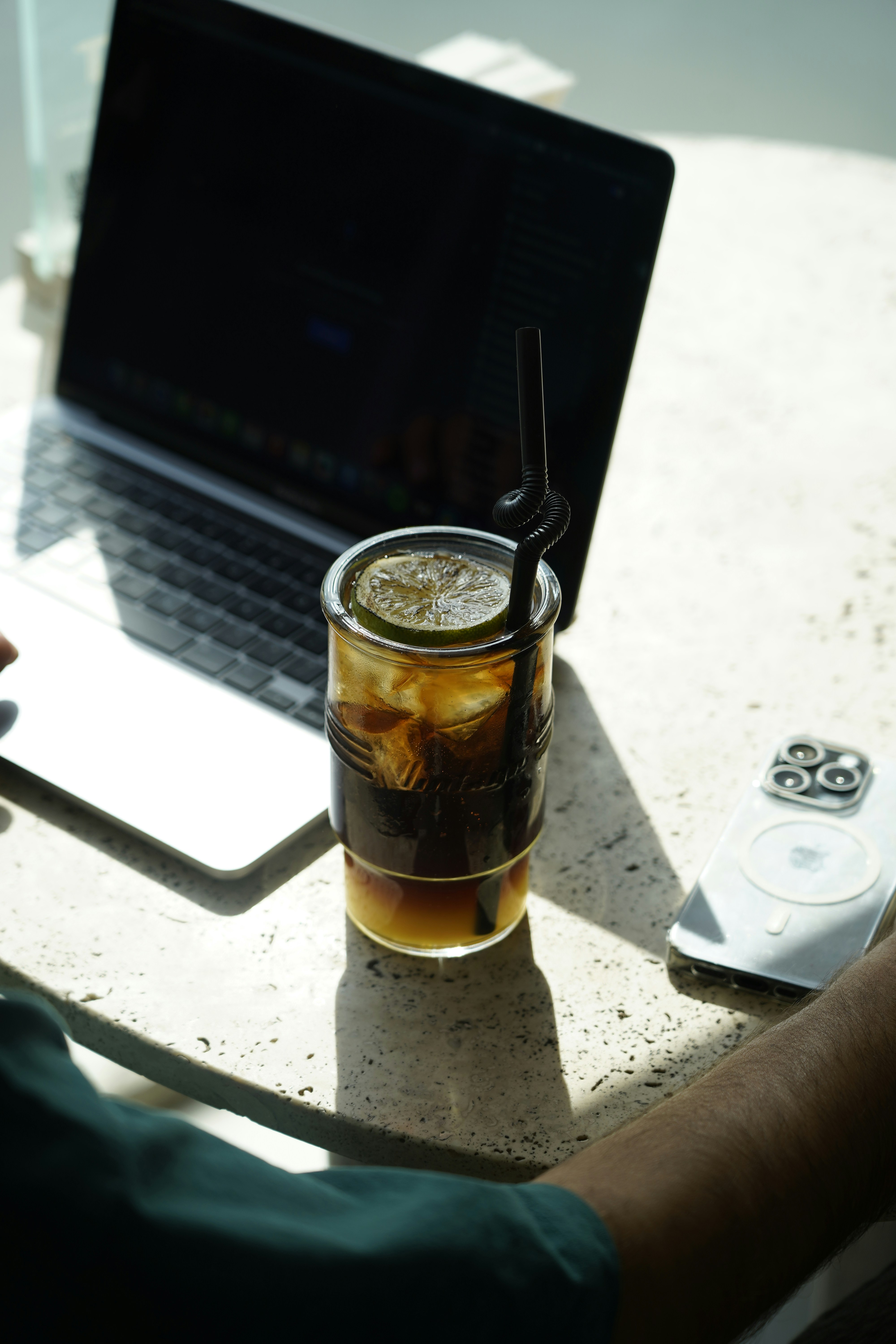 Iced Brew and Laptop Glow on a Sunlit Patio