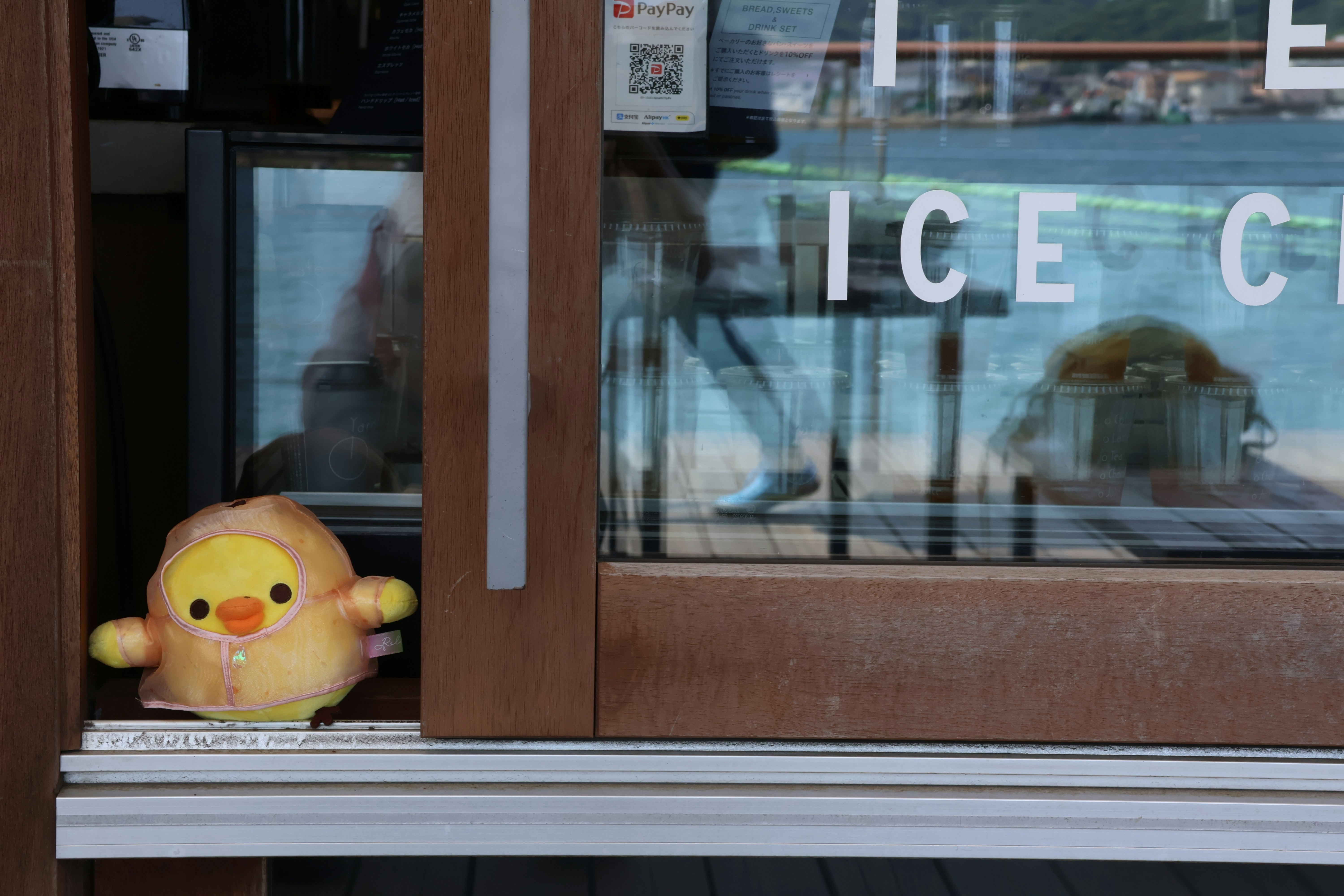 Threshold of Cheer: Plush Chick by the Frosted Window