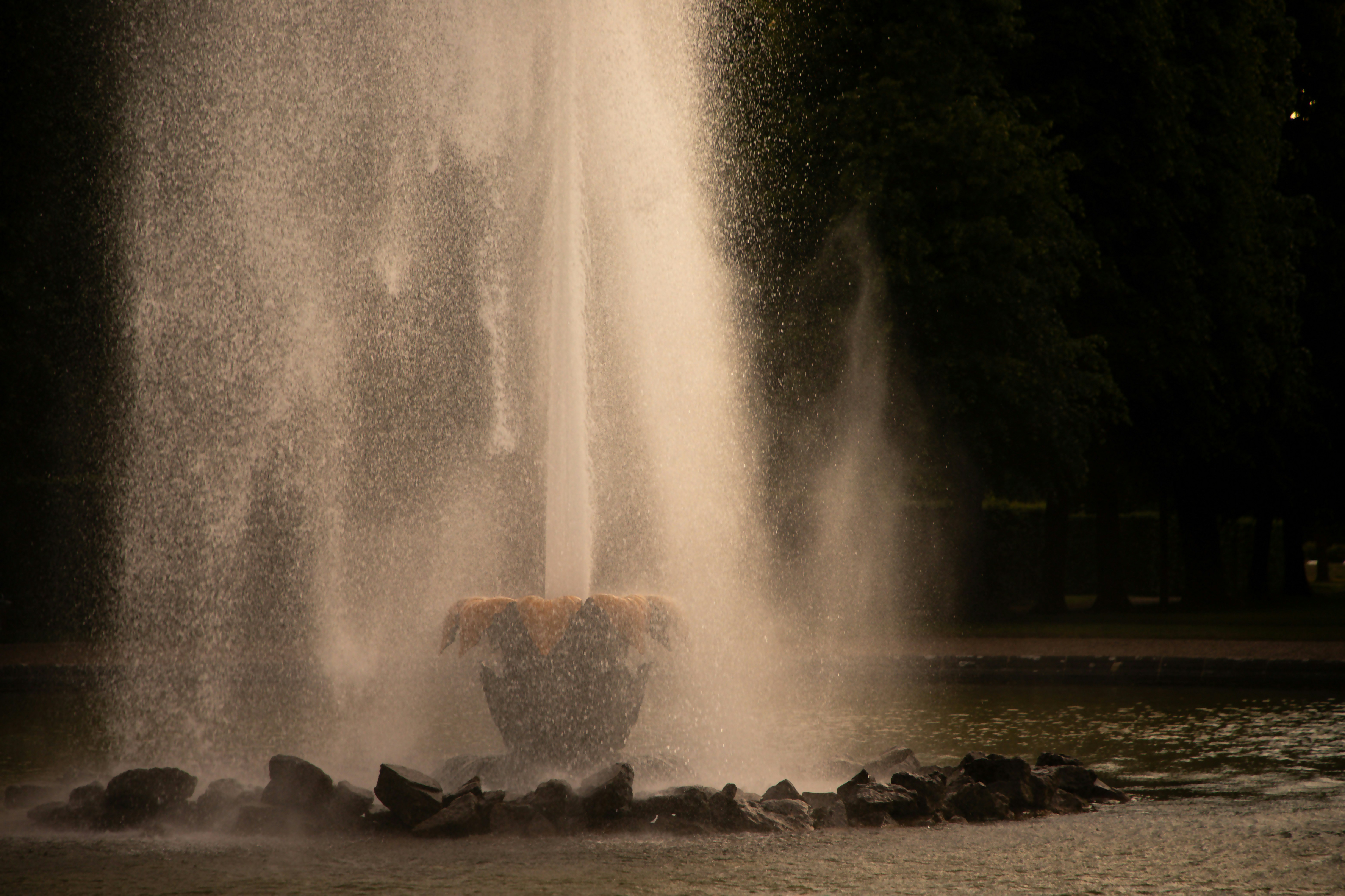 Midnight Cascade: A Quiet Fountain Surging Through Streetlight Mist