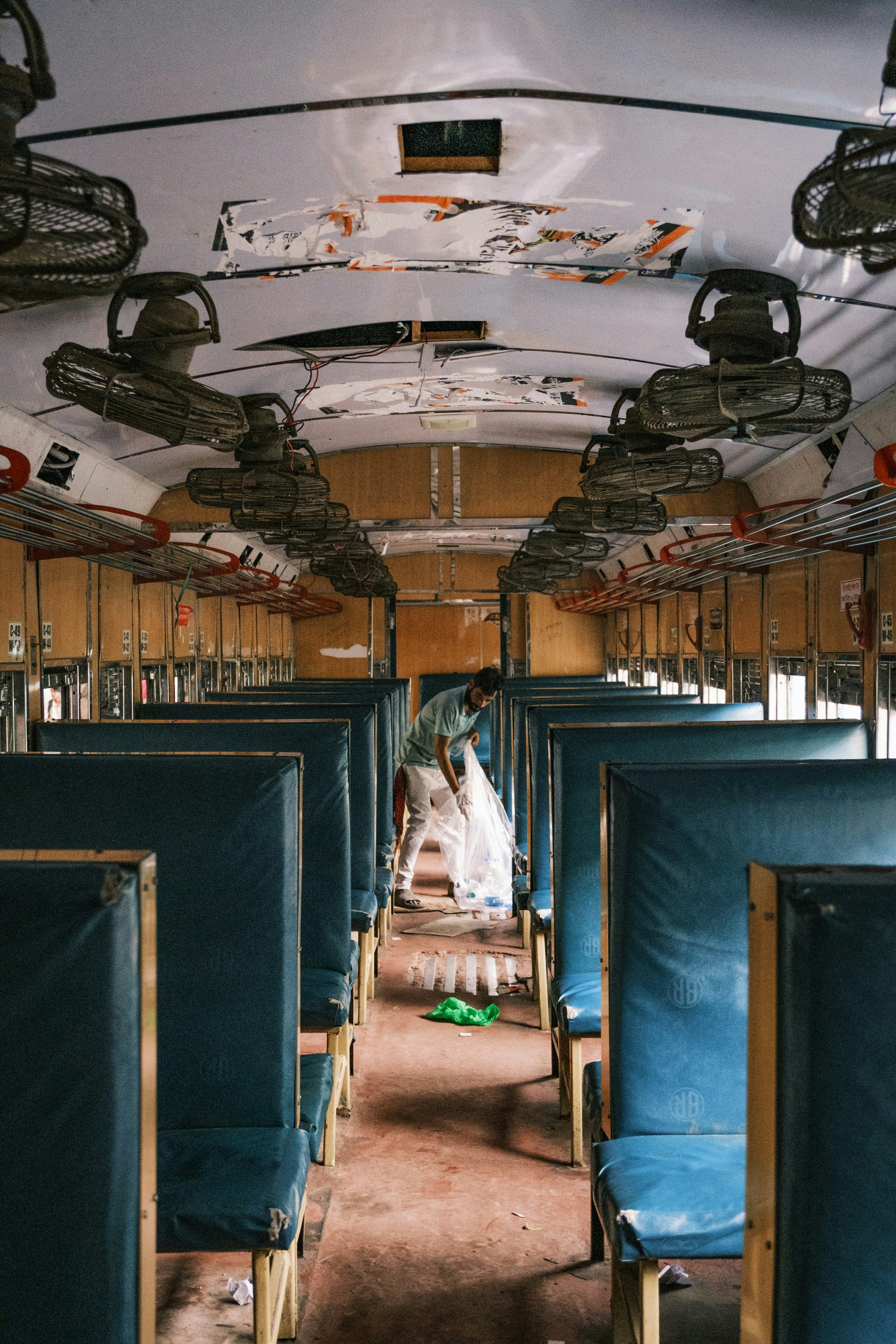 Mid-aisle cleanup aboard a weathered bus