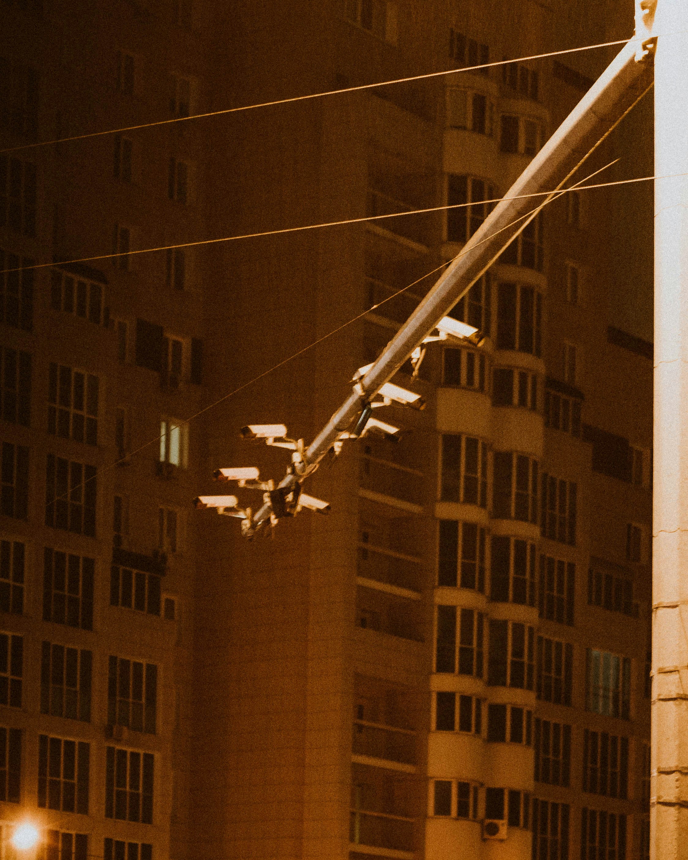 Night urban rig with illuminated streetlight mast and cables