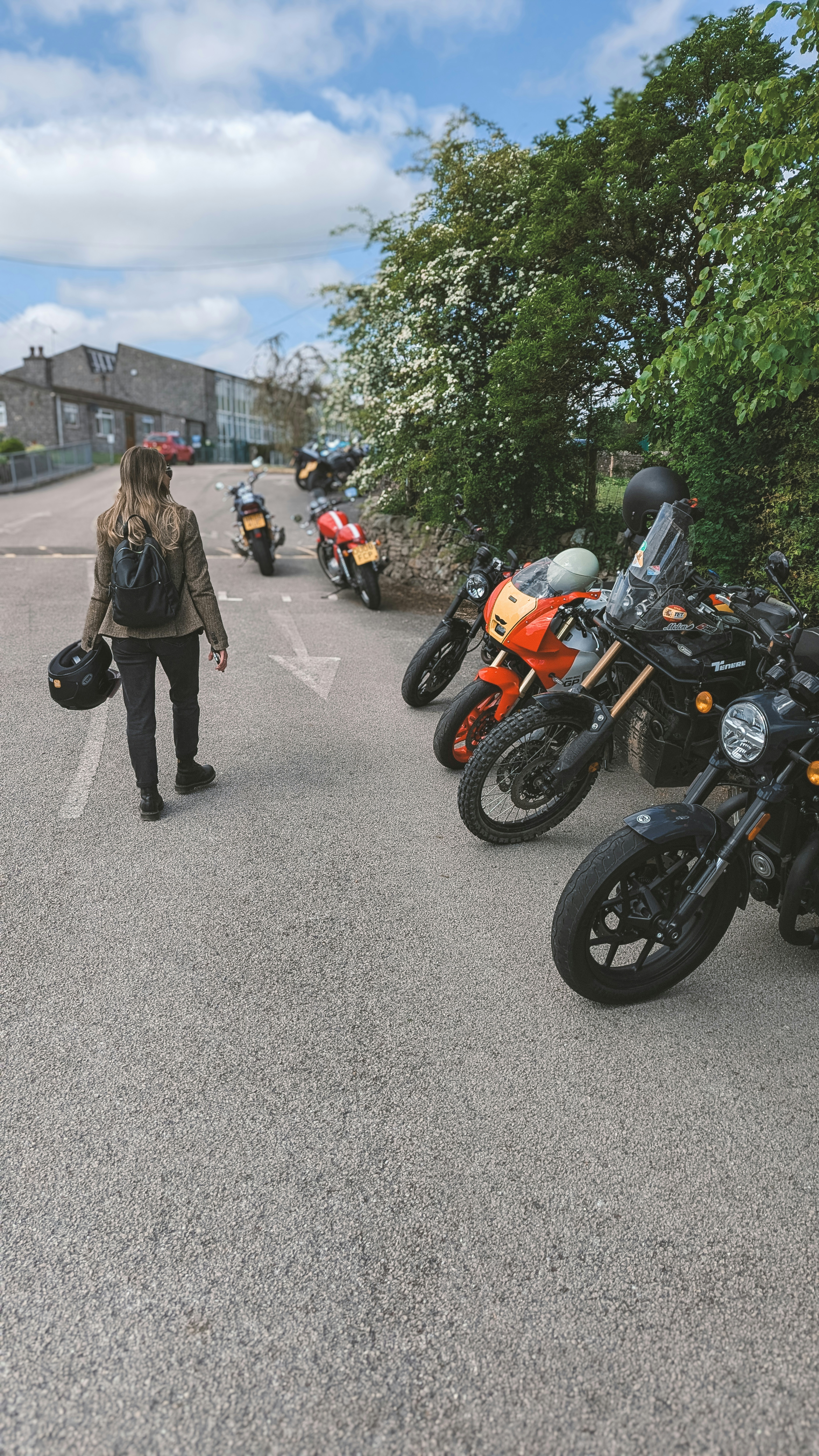 A woman walks toward parked motorcycles. photo – Free Vintage Image on ...