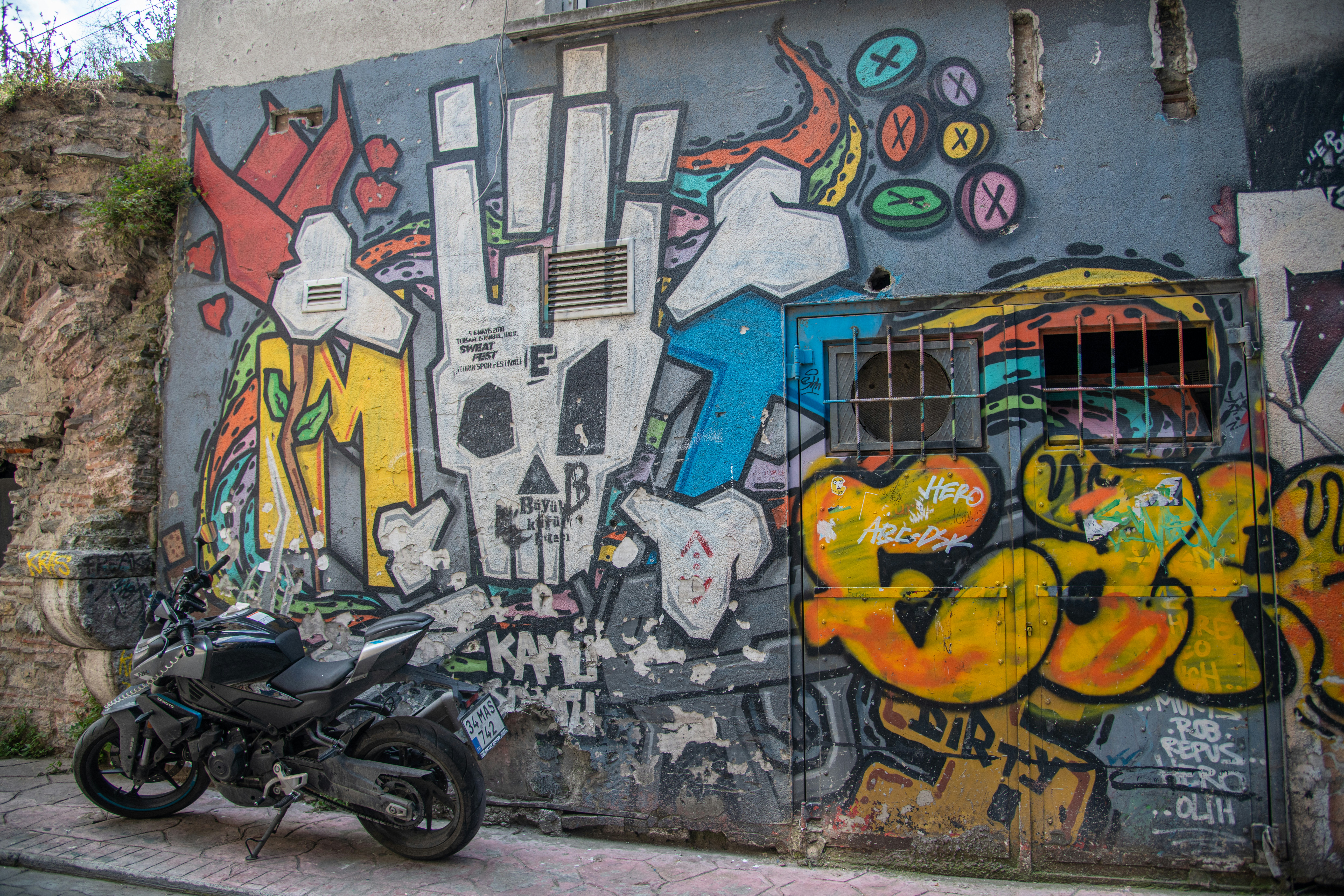 Graffiti Dreams: A Street Mosaic Beneath a Quiet Bike
