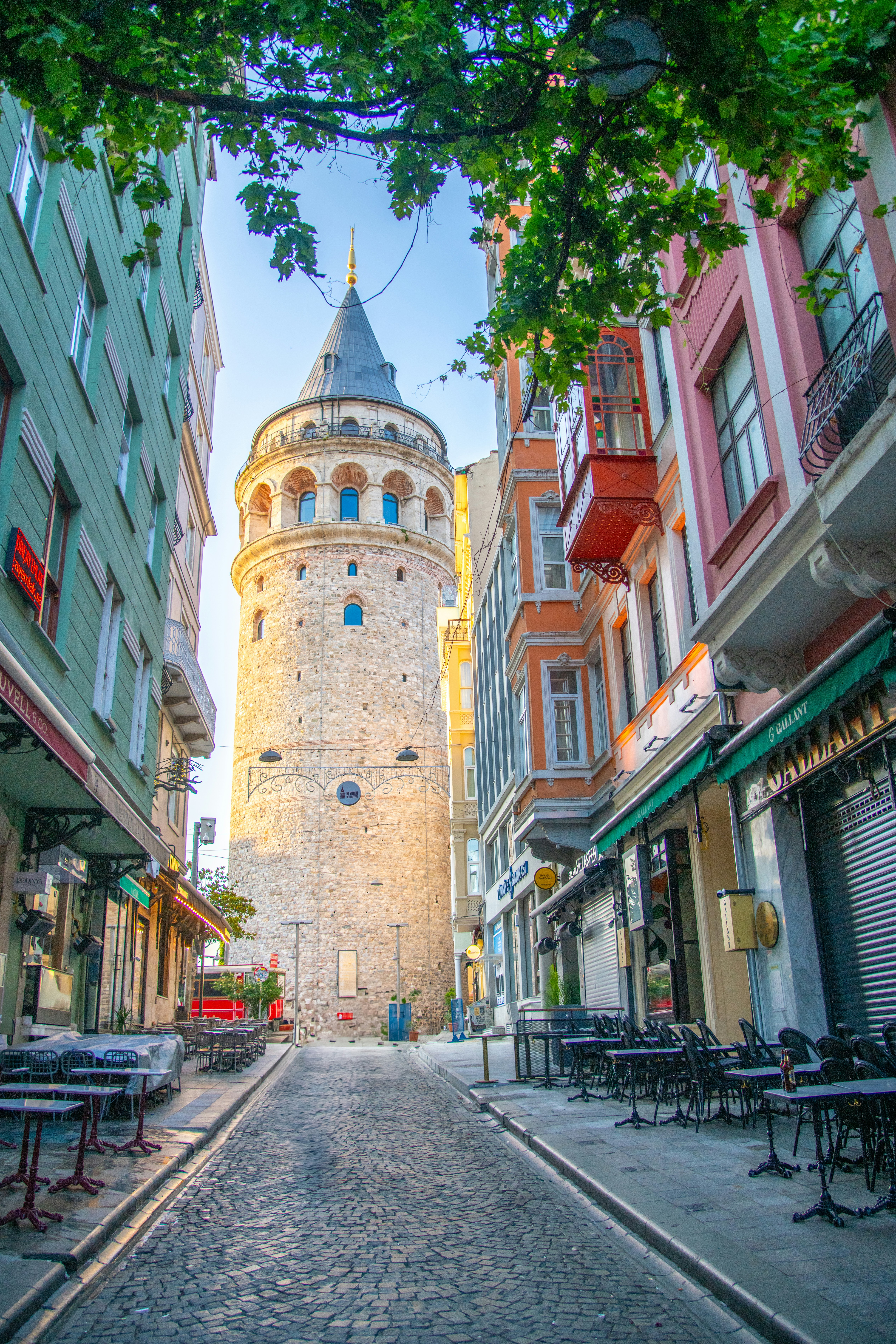 The galata tower rises above a historic street.