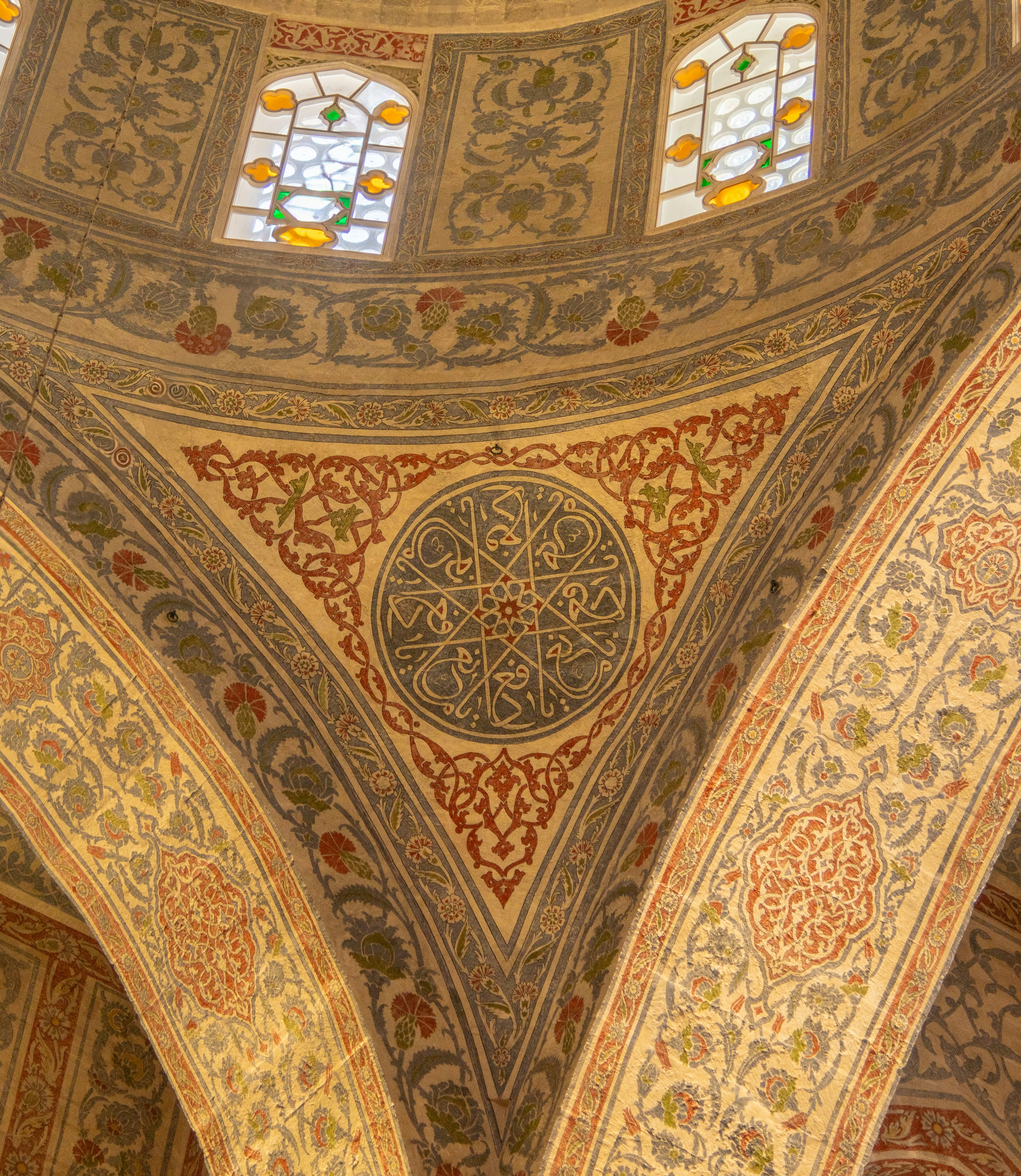 Intricate patterns decorate the ornate ceiling of a building.
